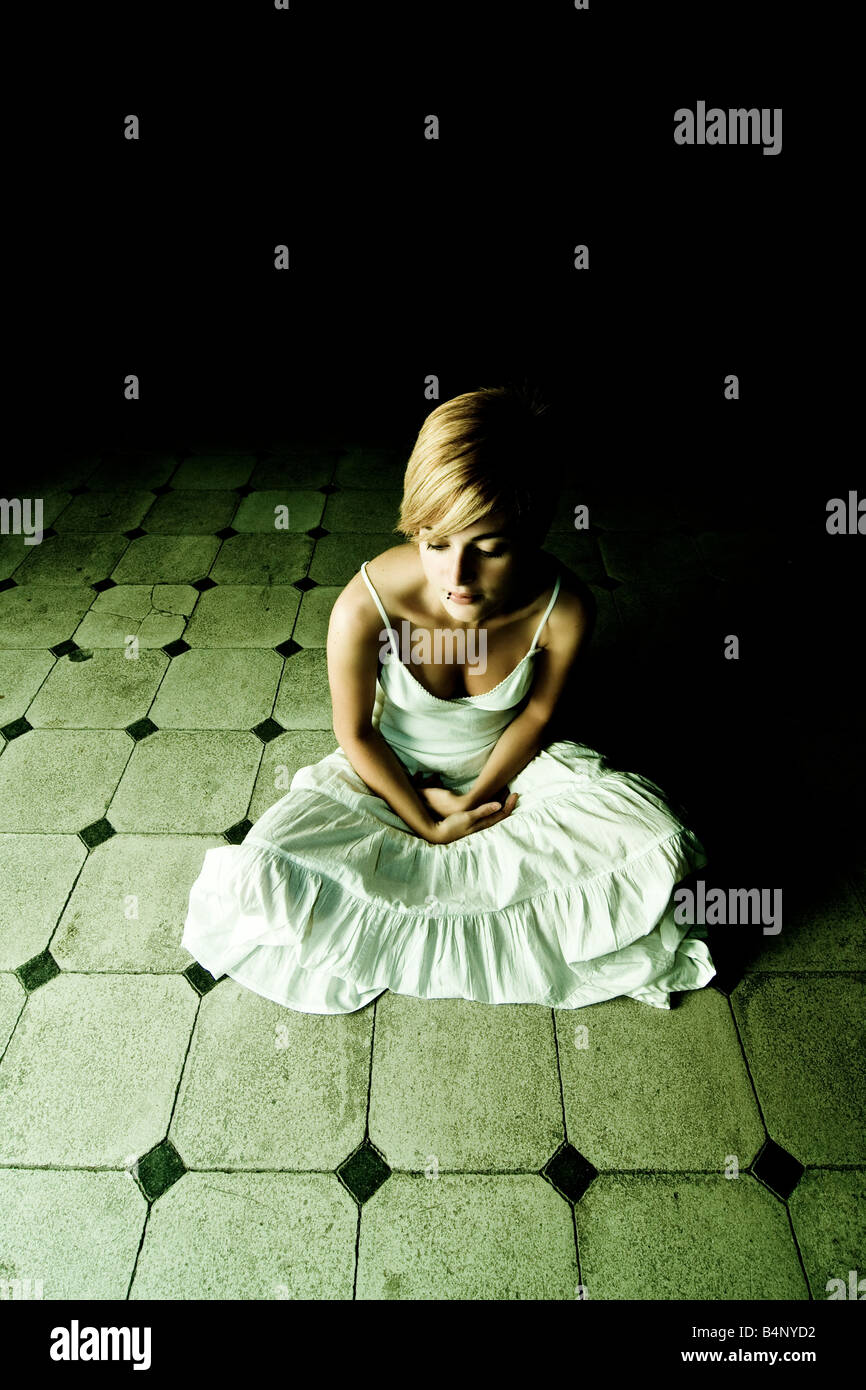 Young beautiful woman surrounded by darkness Stock Photo - Alamy