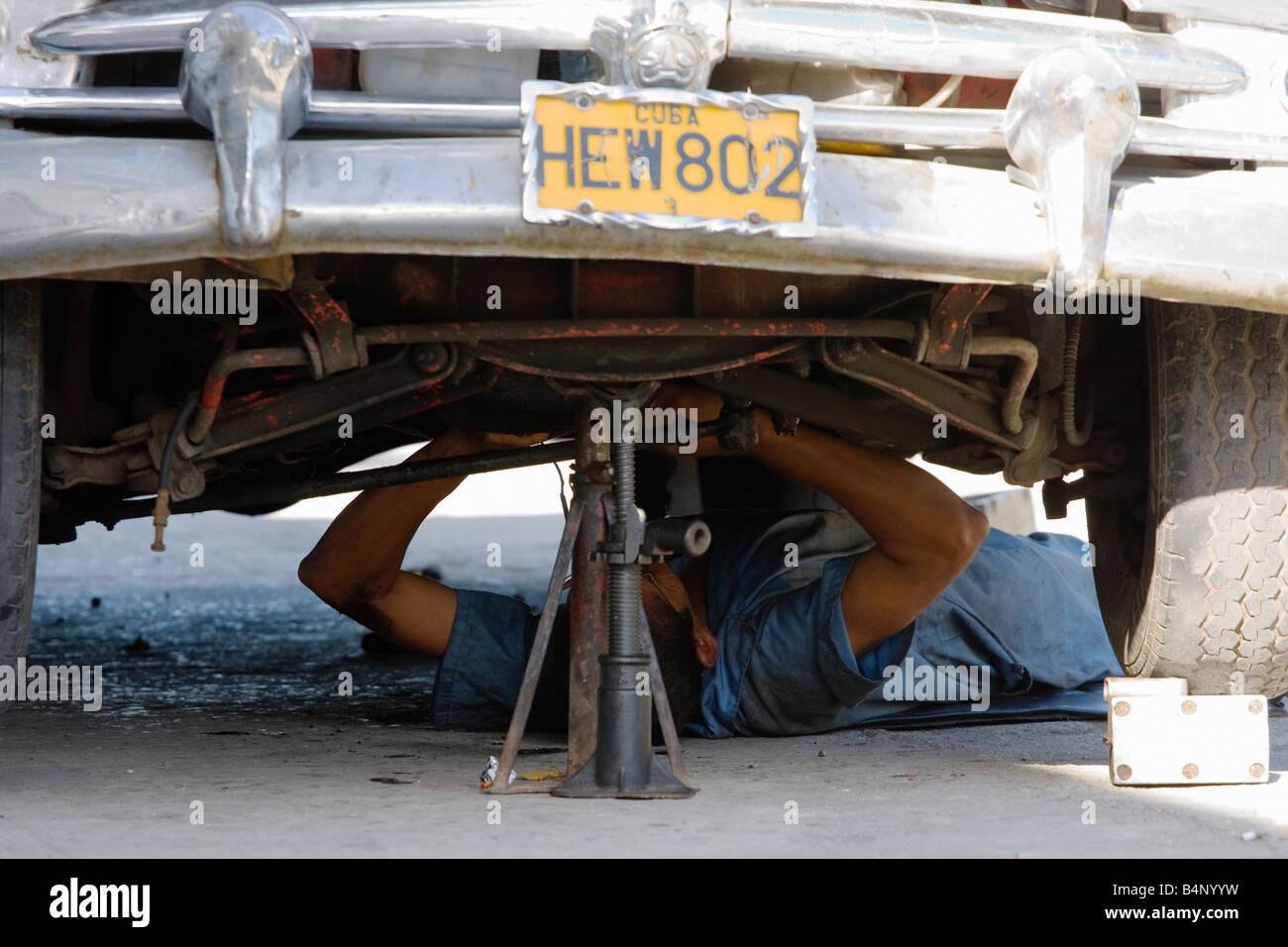 Man repairing his car in the street Stock Photo - Alamy