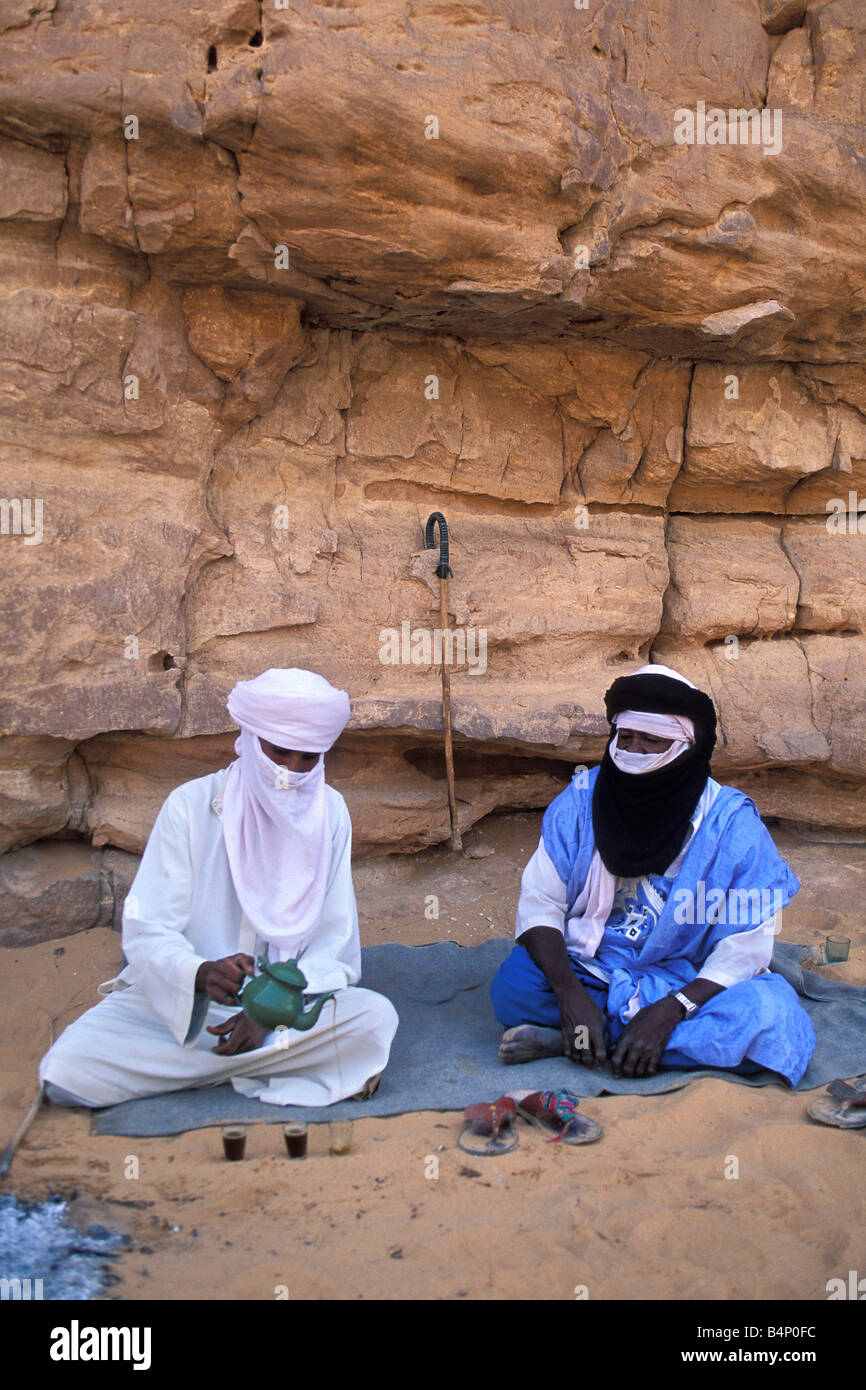 Algeria Djanet Men of Tuareg tribe making tea Sahara desert Stock Photo ...