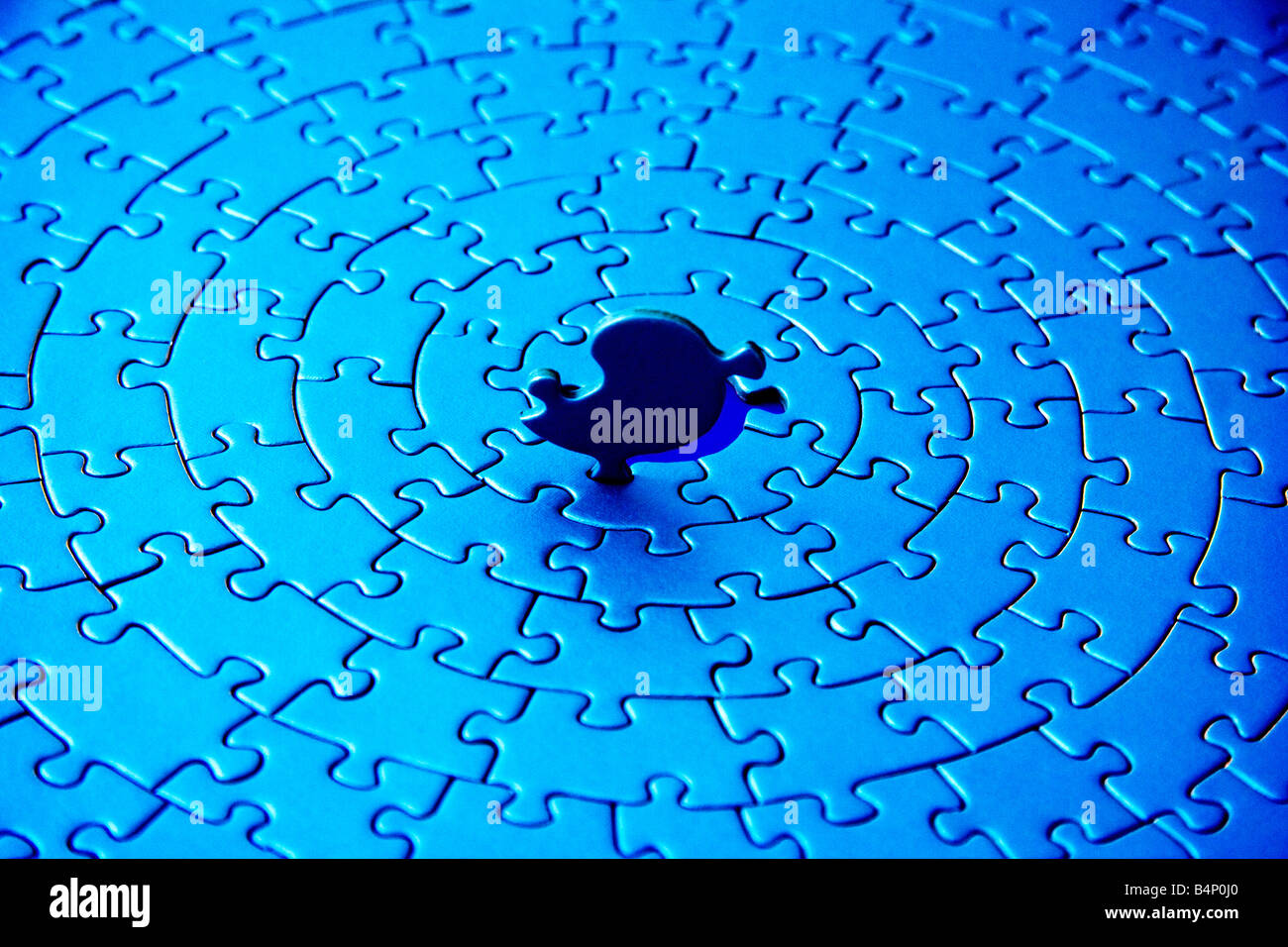 abstract of a blue jigsaw with the last piece upstanding pieces fitting ...