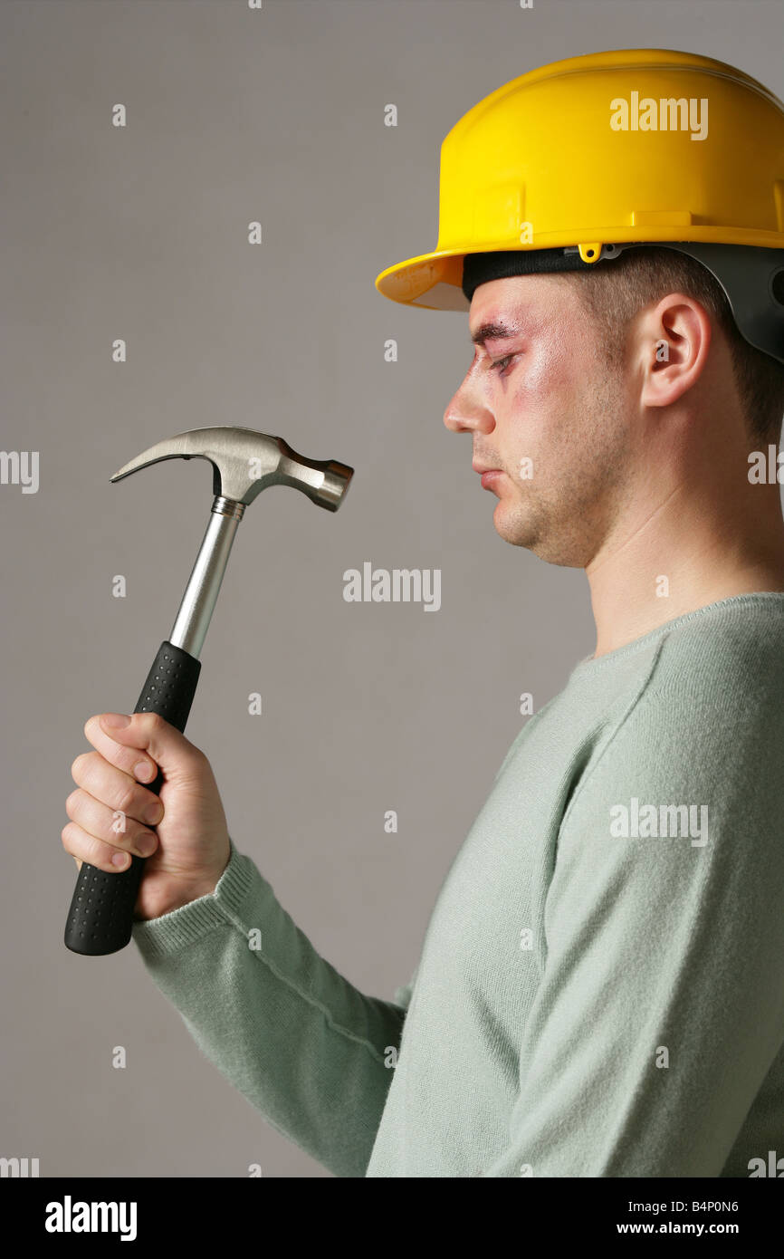 “Male model James wearing a hard hat holding a claw hammer” Stock Photo ...