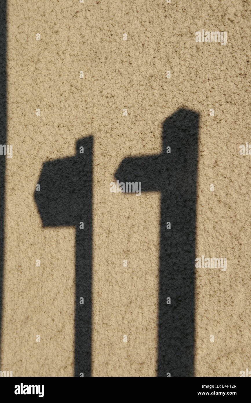 two footpath signs shadow on house wall in sun Stock Photo - Alamy