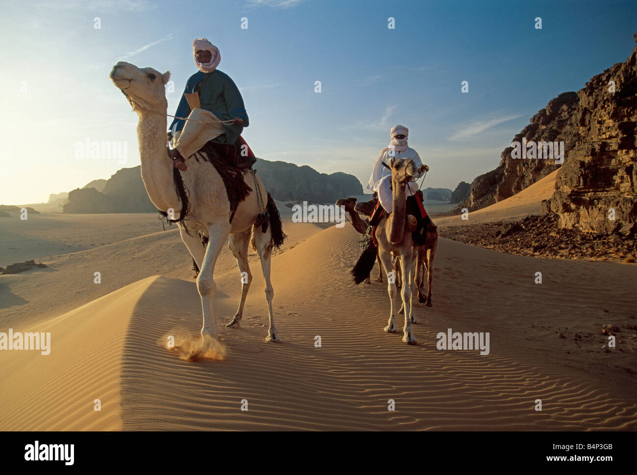 Algeria, near Djanet, Men of Tuareg tribe and camel caravan. Sahara ...