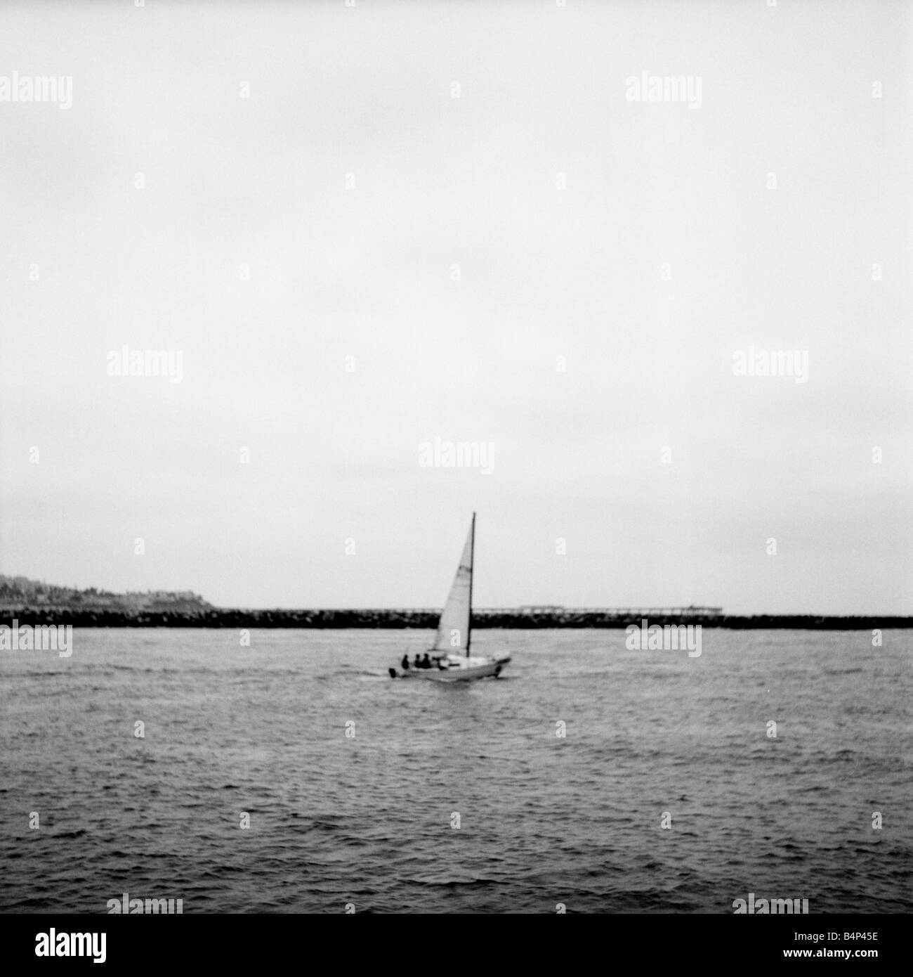 Sailboat sailing through the jetty channel at Mission Beach, California ...