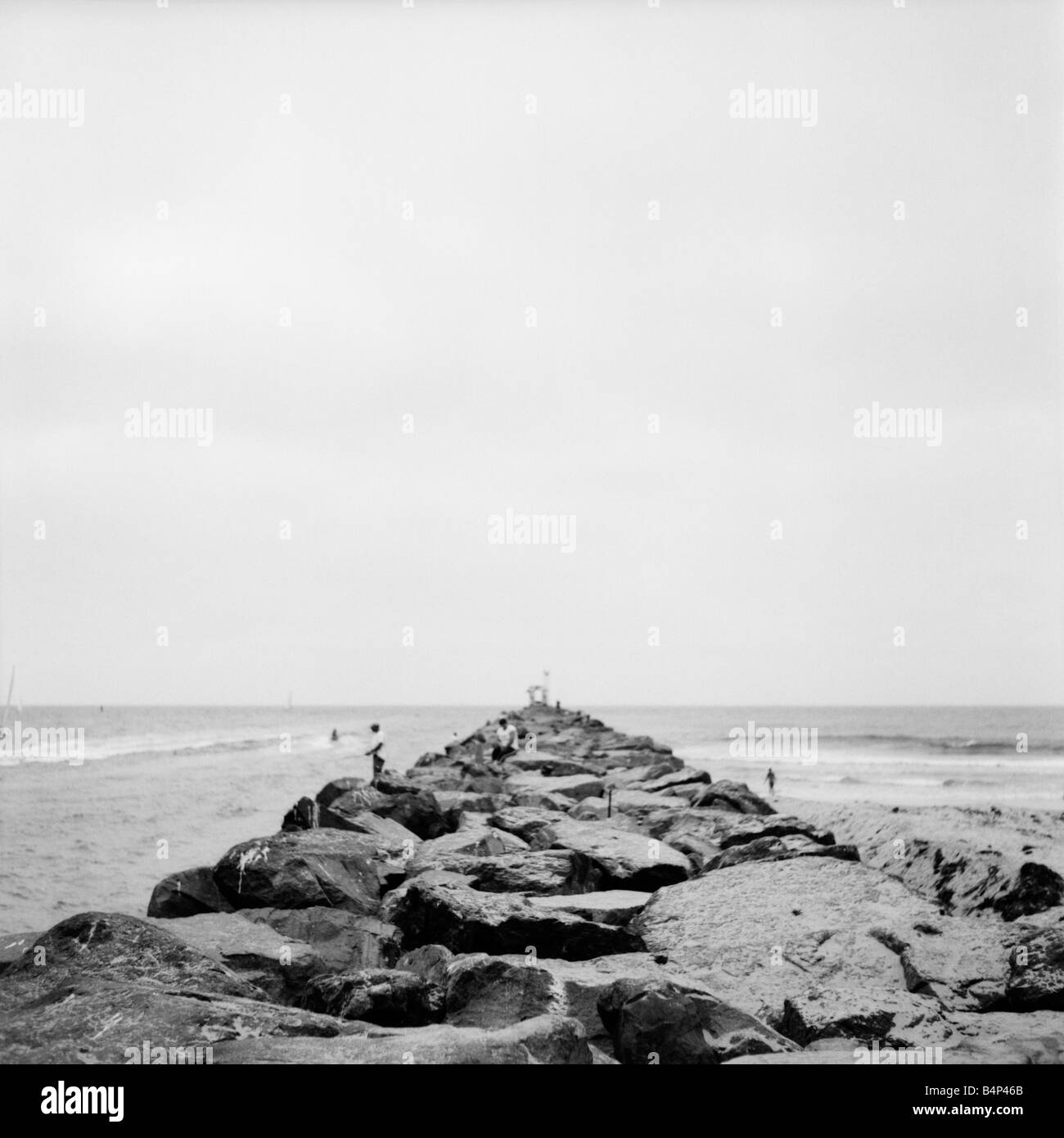 Beach with rock jetty hi-res stock photography and images - Alamy