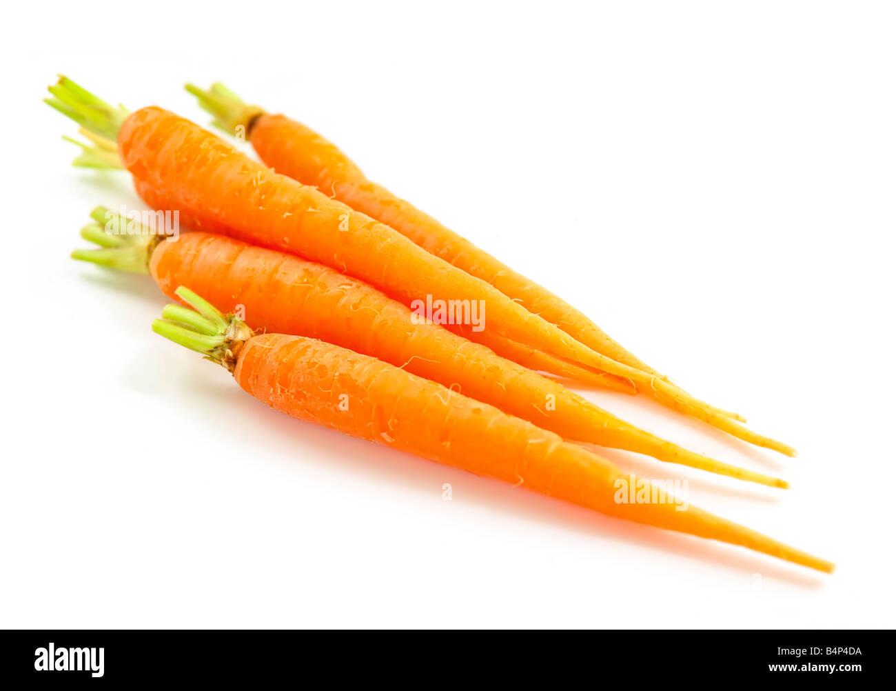 Several fresh carrots isolated on white background Stock Photo - Alamy