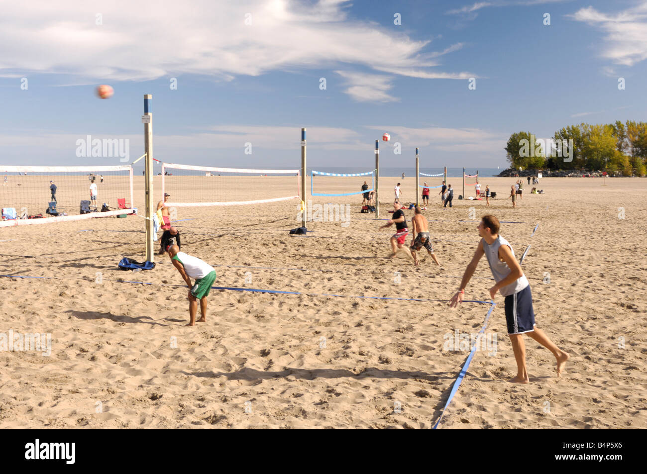 People playing volleyball on the beach Stock Photo - Alamy