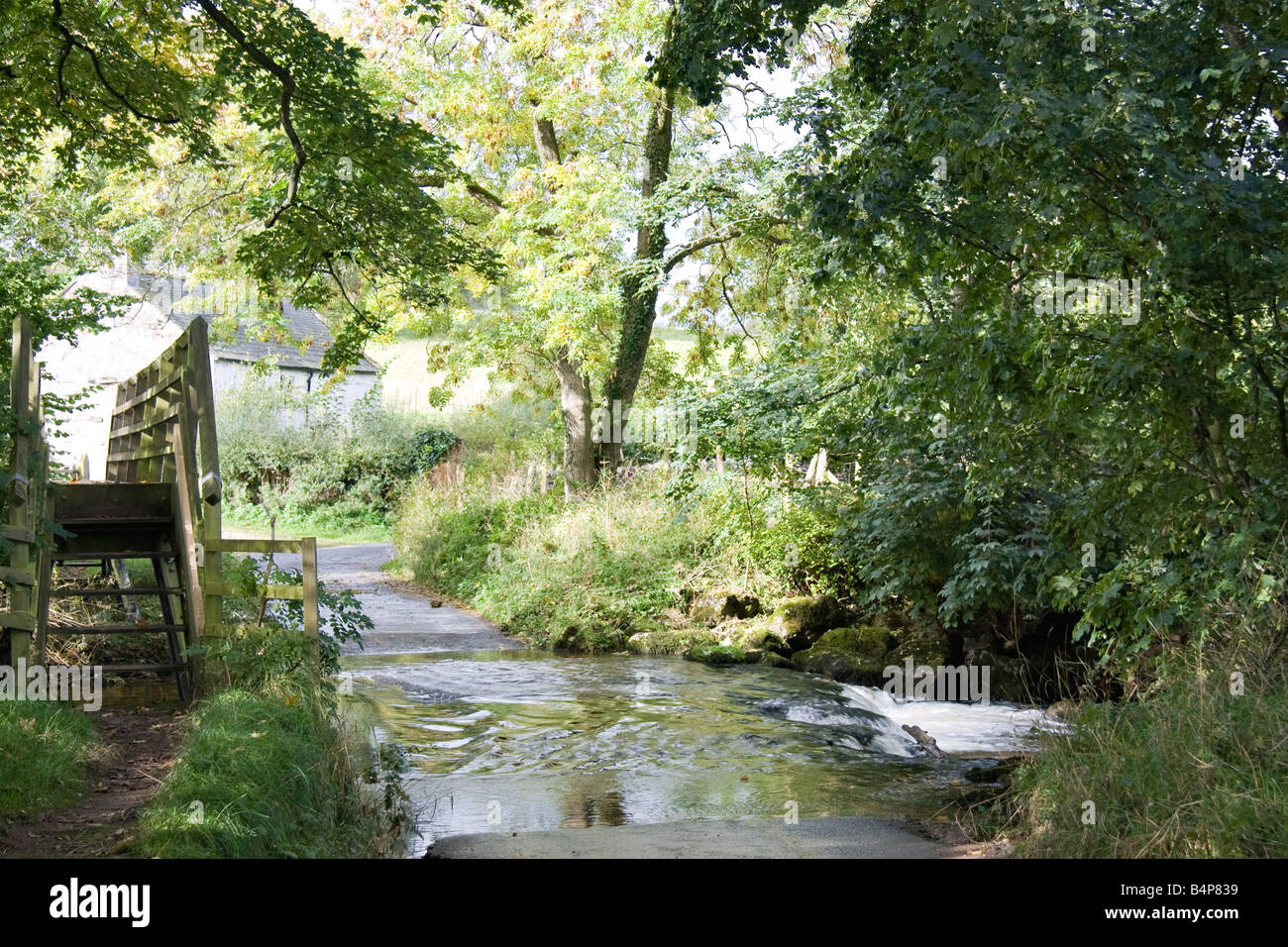 A lane fords a small river with a footbridge Stock Photo - Alamy