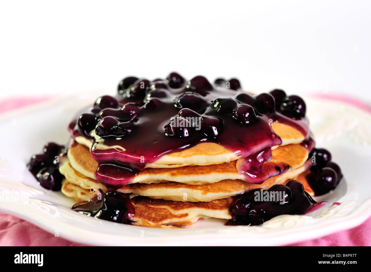 A stack of four pancakes with blueberry topping for breakfast or brunch ...
