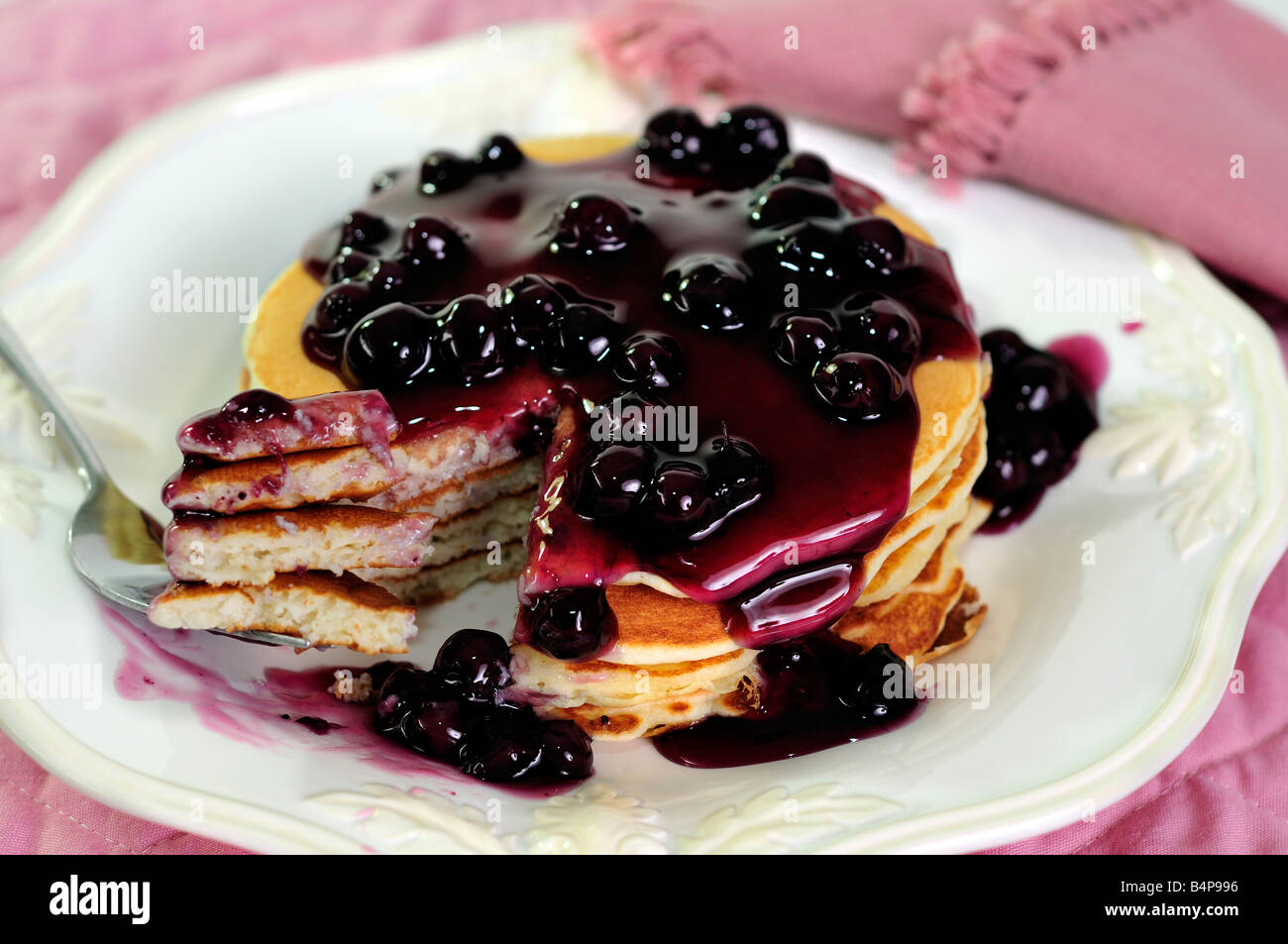 A stack of four pancakes with blueberry topping for breakfast or brunch ...