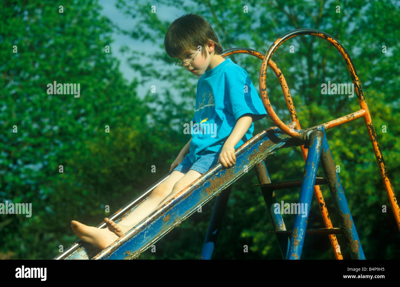 young boy on a slide Stock Photo - Alamy