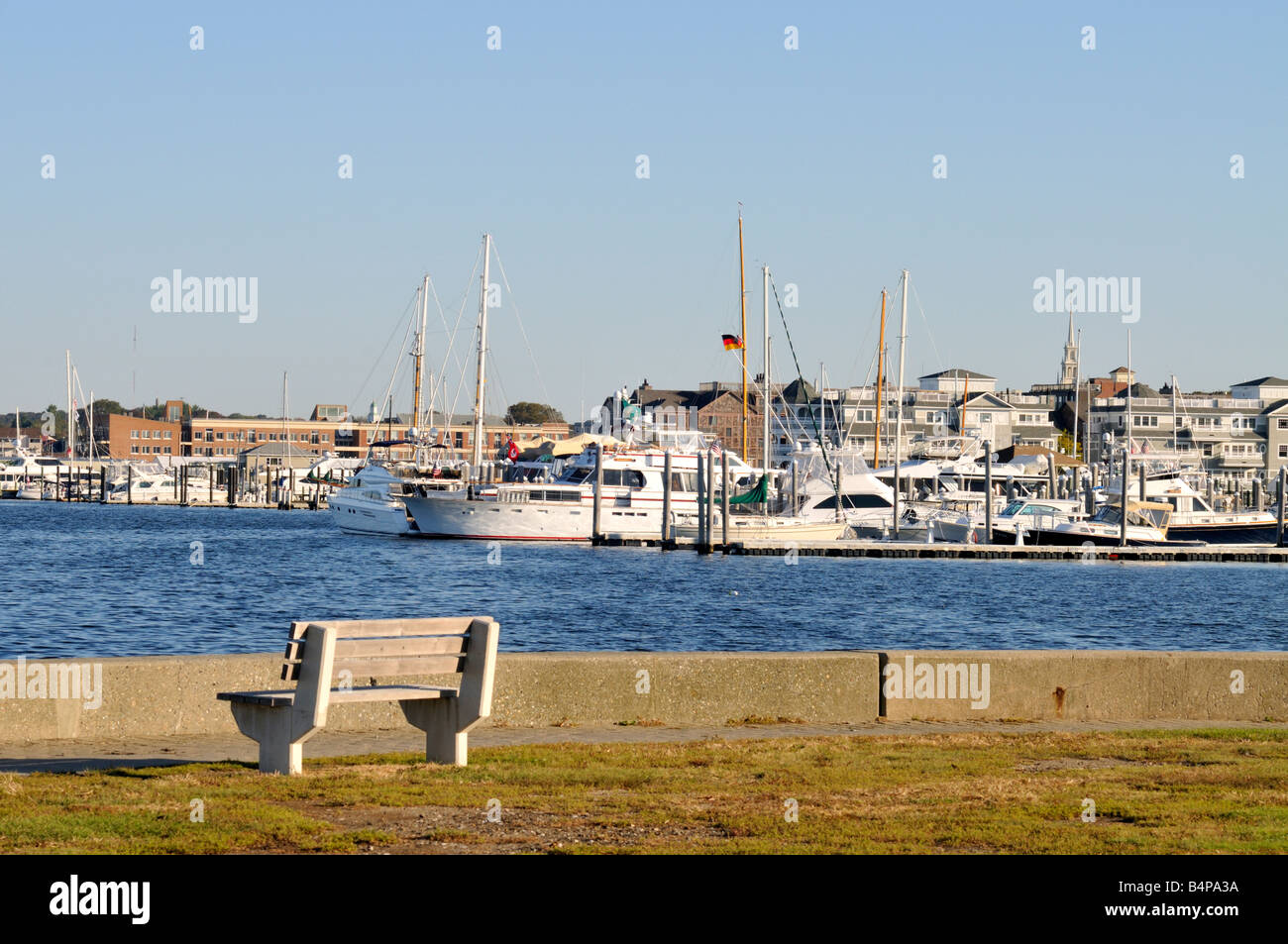 View of Newport Harbor and marina with boats at dock from park with ...