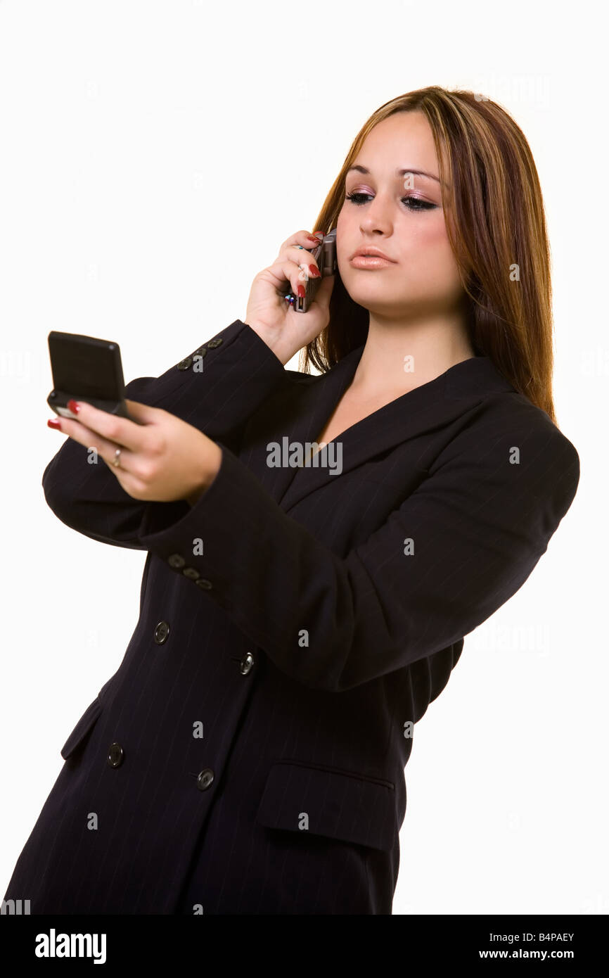 Woman text messaging while on the phone Stock Photo - Alamy