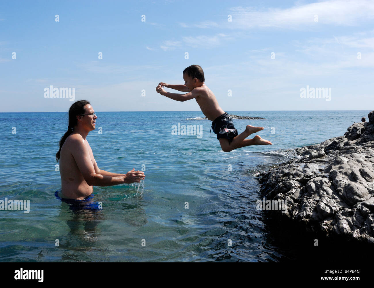 Children jumping off a rock hi-res stock photography and images - Alamy
