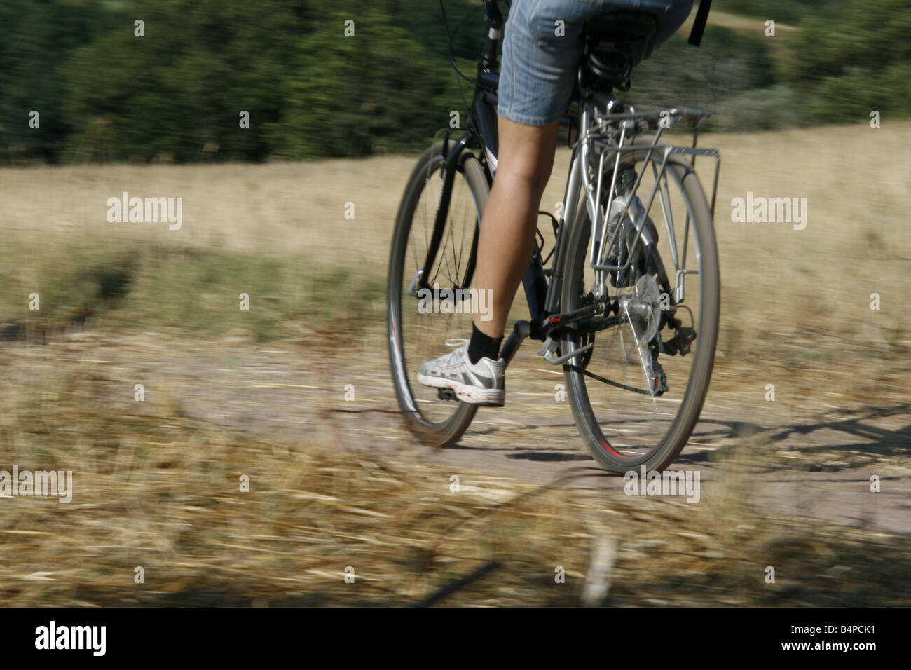 one person riding bike in countryside Stock Photo - Alamy