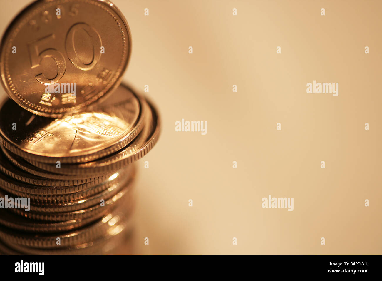 Coin balancing on coin stack Stock Photo - Alamy