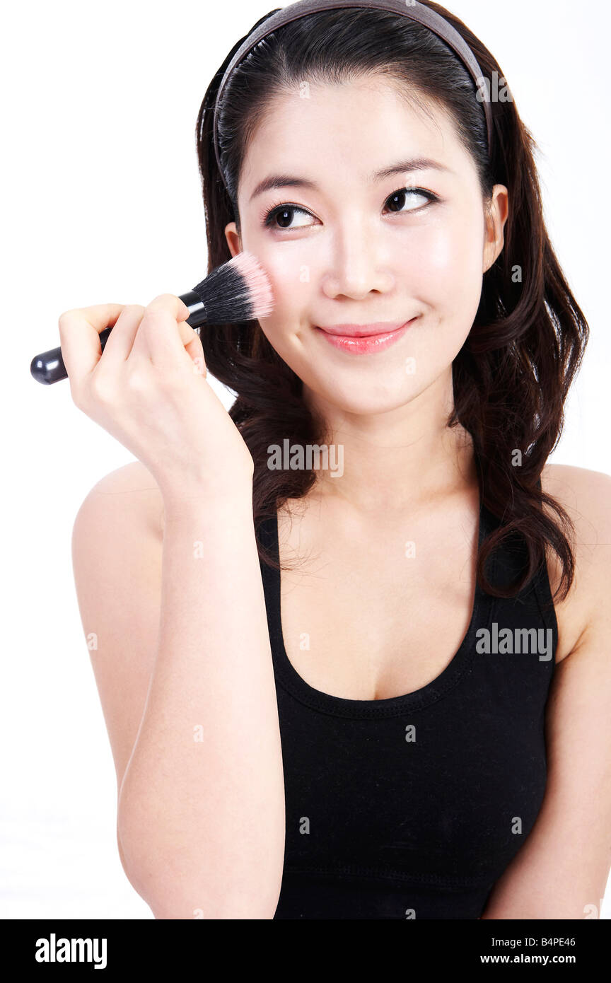 Young woman applying make up Stock Photo - Alamy