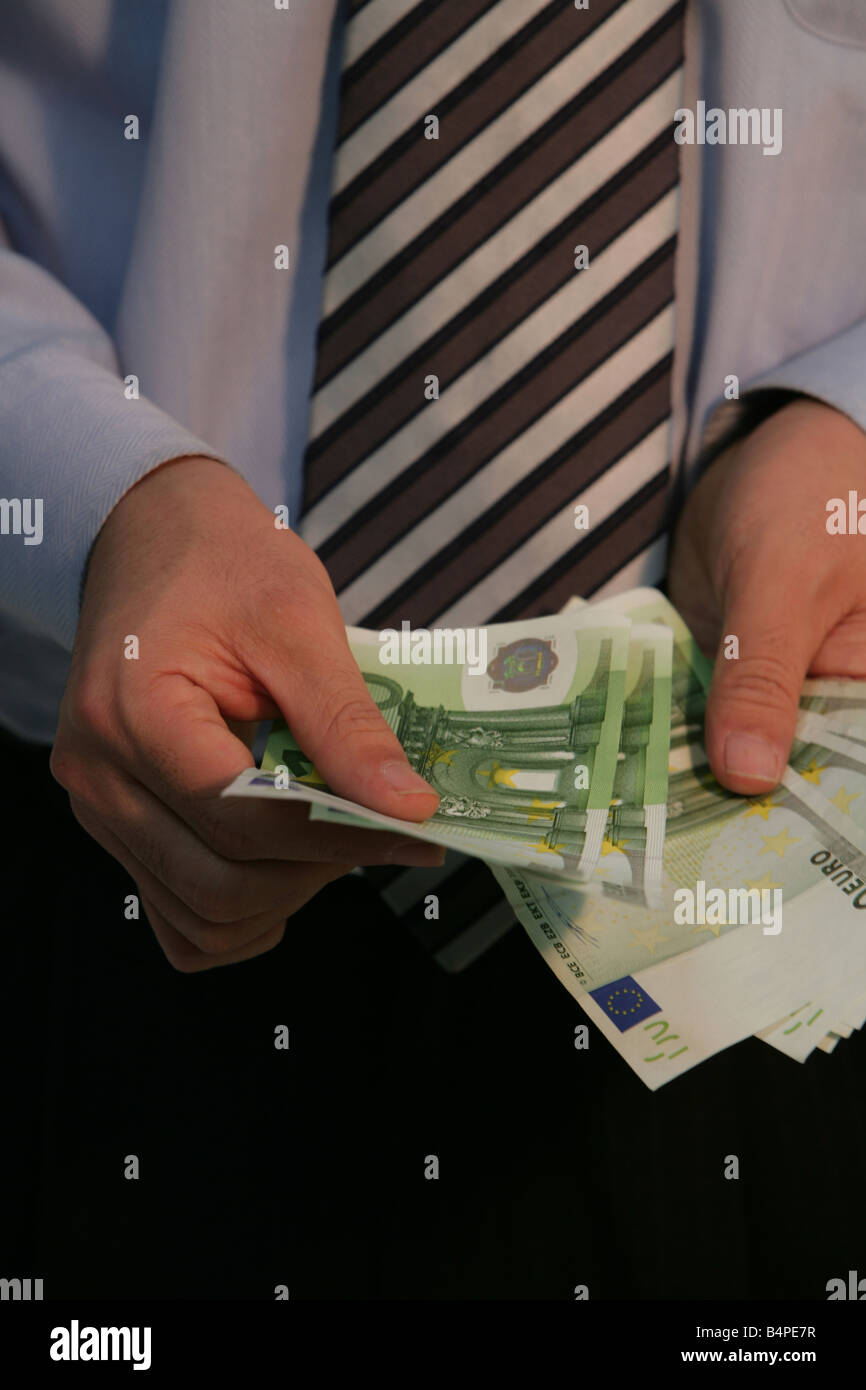 Businessman making finances counting money hi-res stock photography and ...