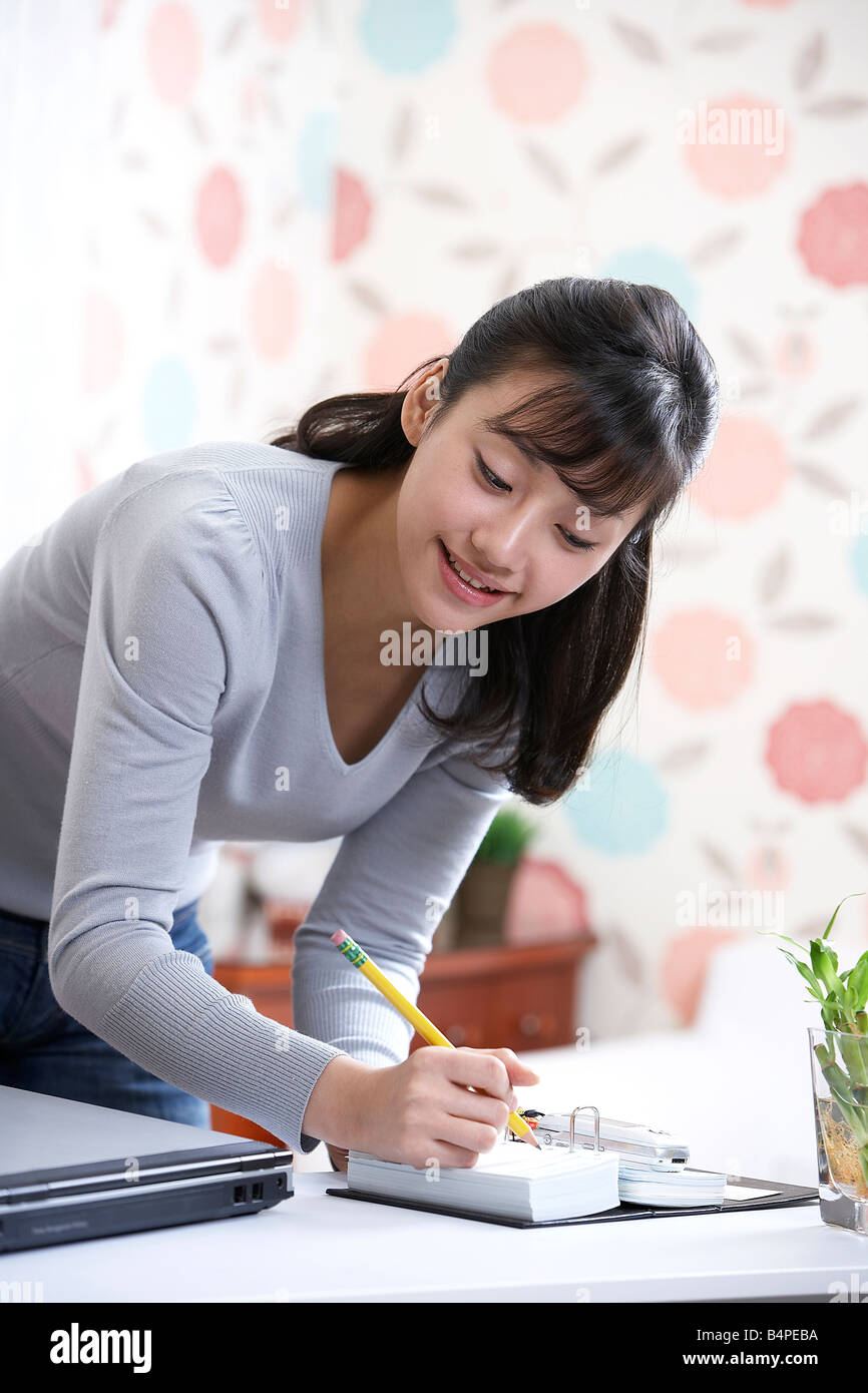 Young woman writing book Stock Photo - Alamy