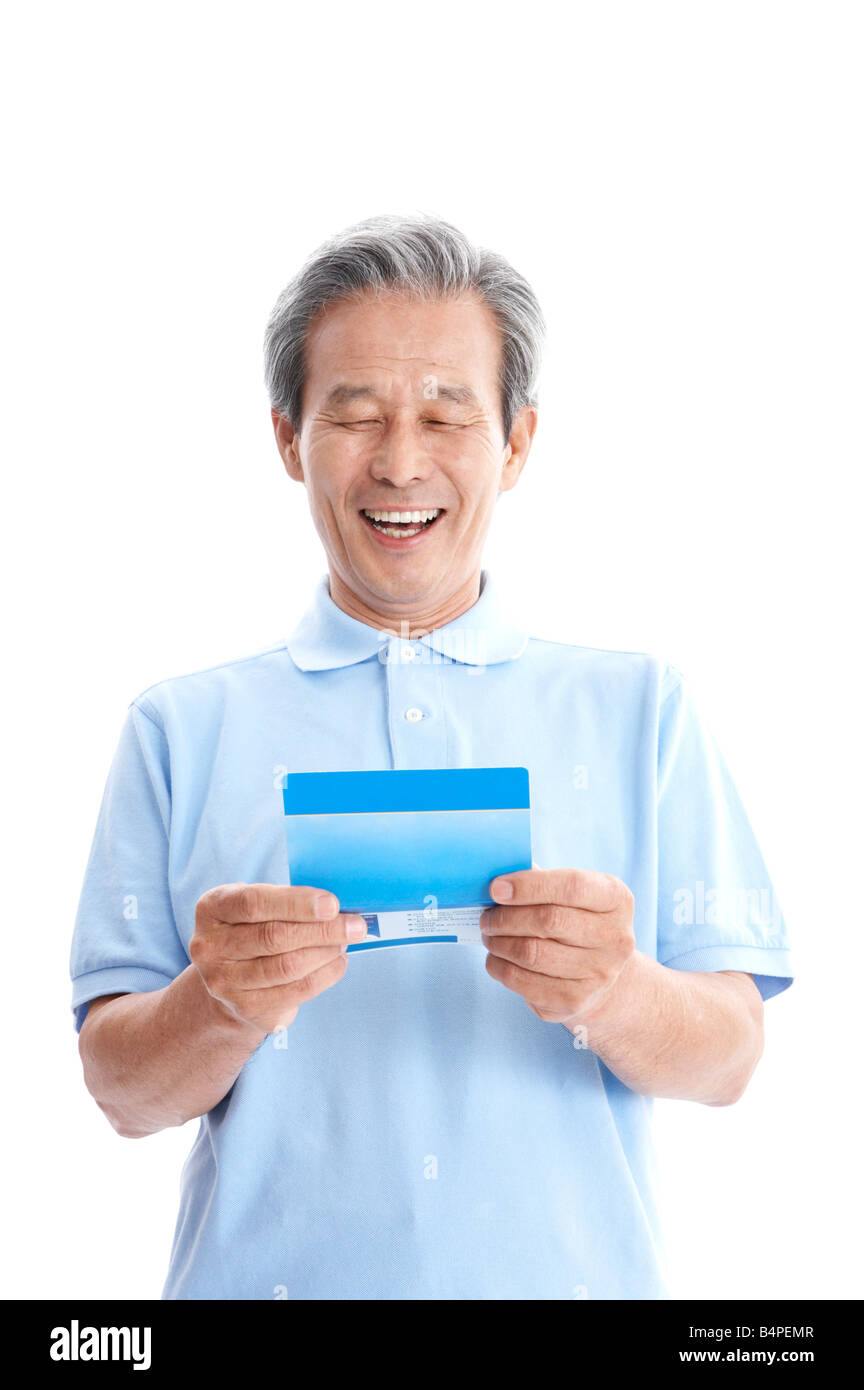 Mature man reading card, smiling Stock Photo - Alamy