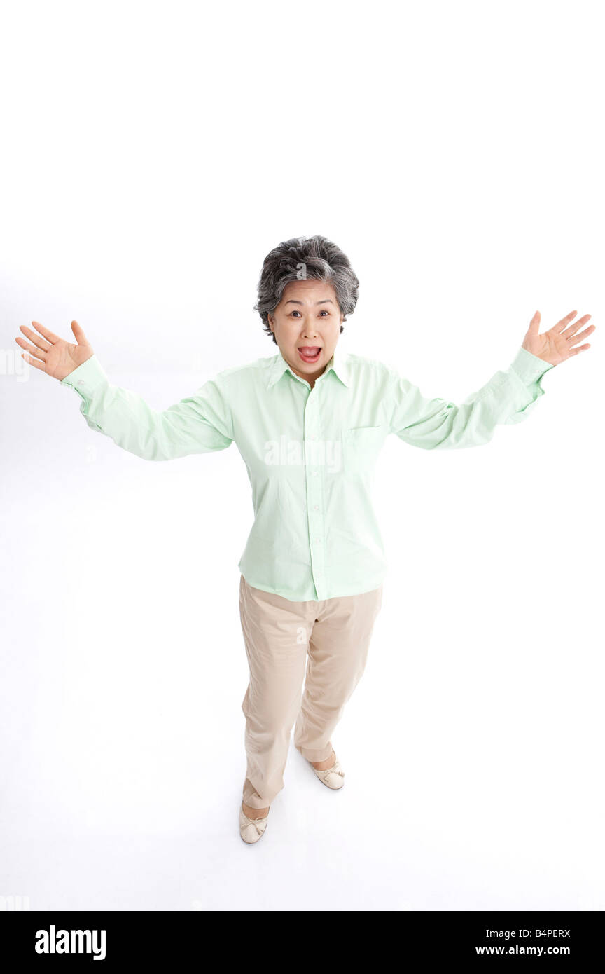 Mature woman with arms raised, smiling, portrait Stock Photo - Alamy