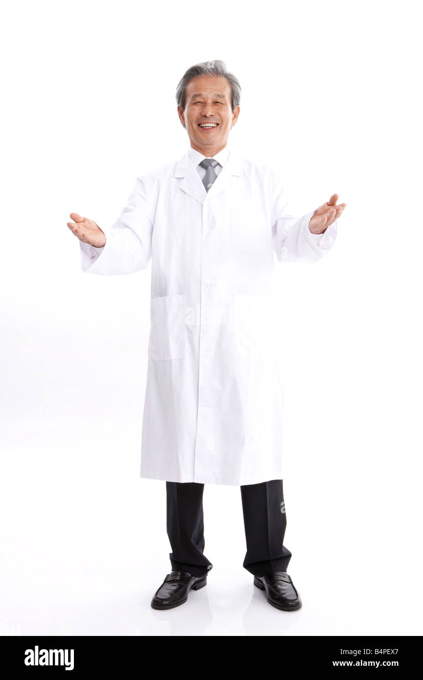 Male doctor standing with arms out, smiling Stock Photo - Alamy