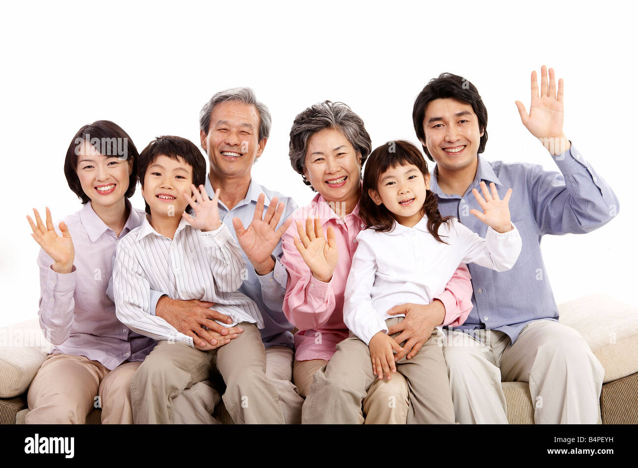 Portrait of family waving Stock Photo - Alamy