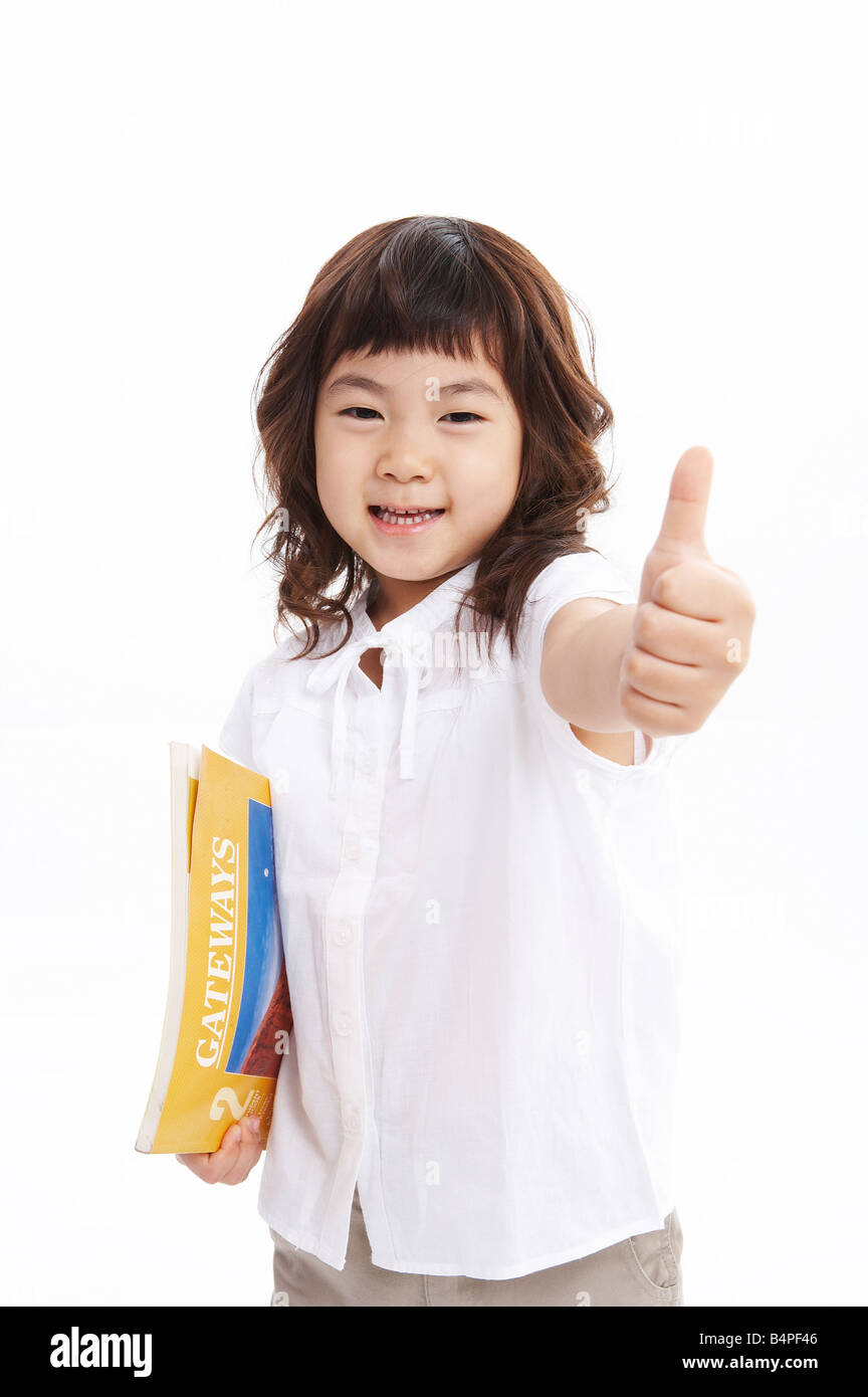 Girl with book doing thumbs up Stock Photo - Alamy