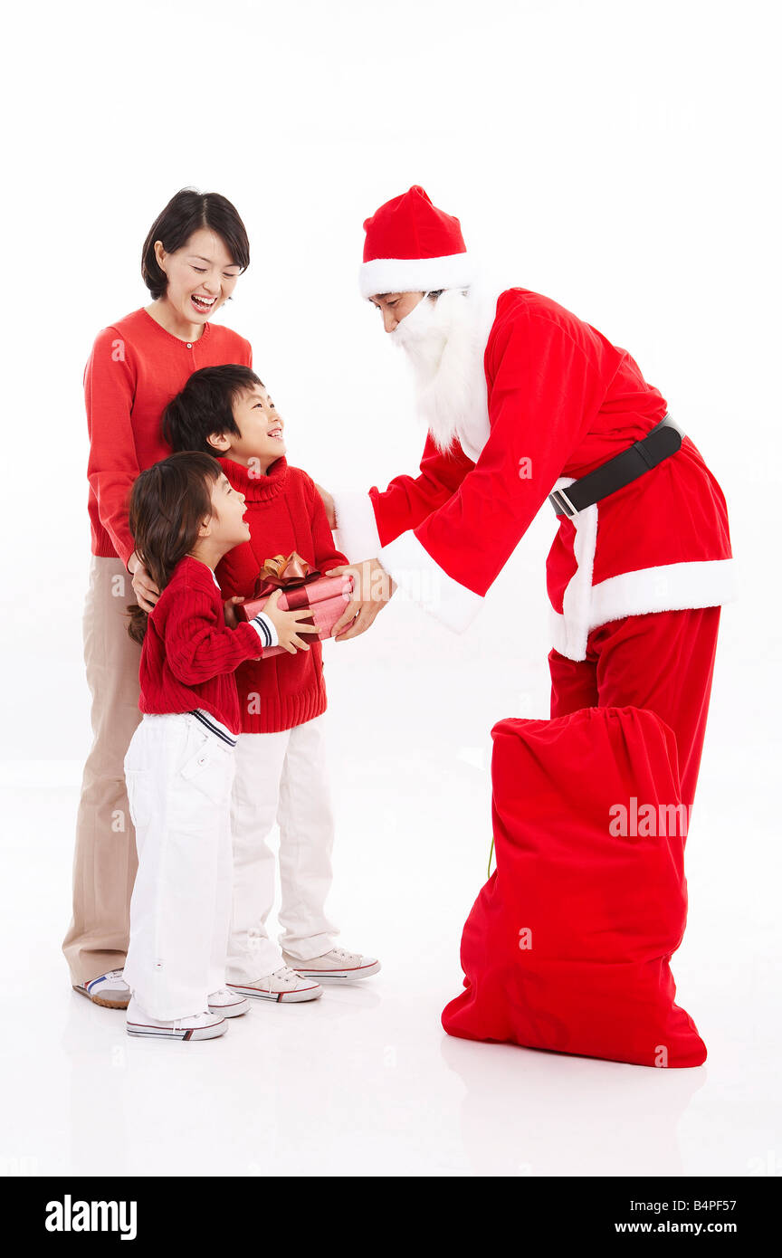 Santa Claus giving gift to children Stock Photo - Alamy