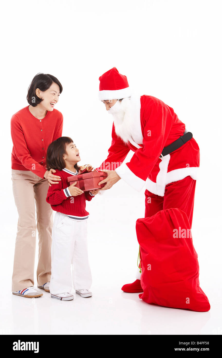 Santa Claus giving gift to girl Stock Photo - Alamy