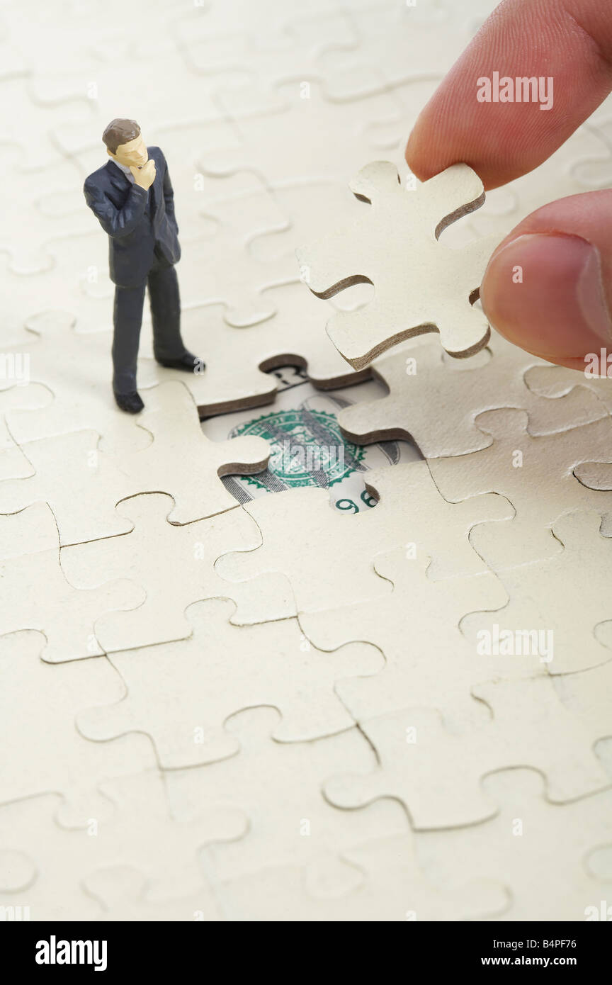 Male figurine thinking while human hand keeping puzzle Stock Photo - Alamy