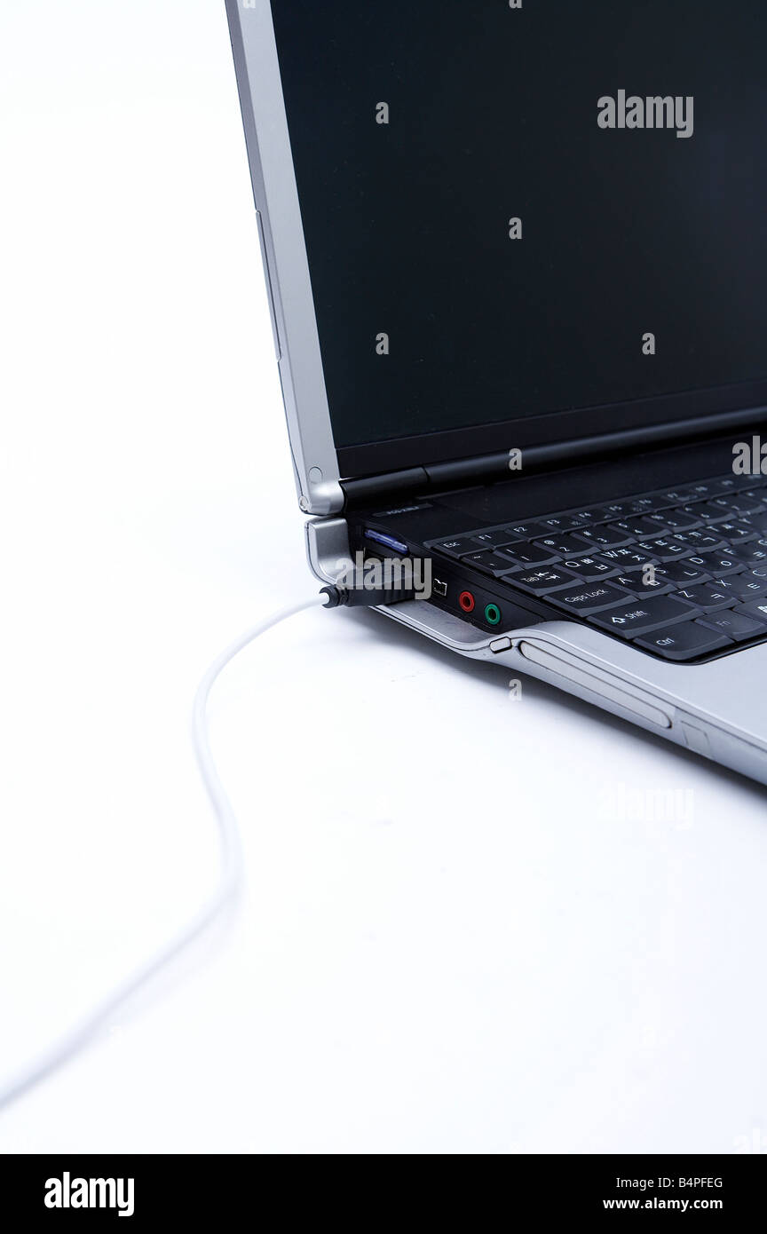 Laptop plugged with cable, close-up Stock Photo - Alamy