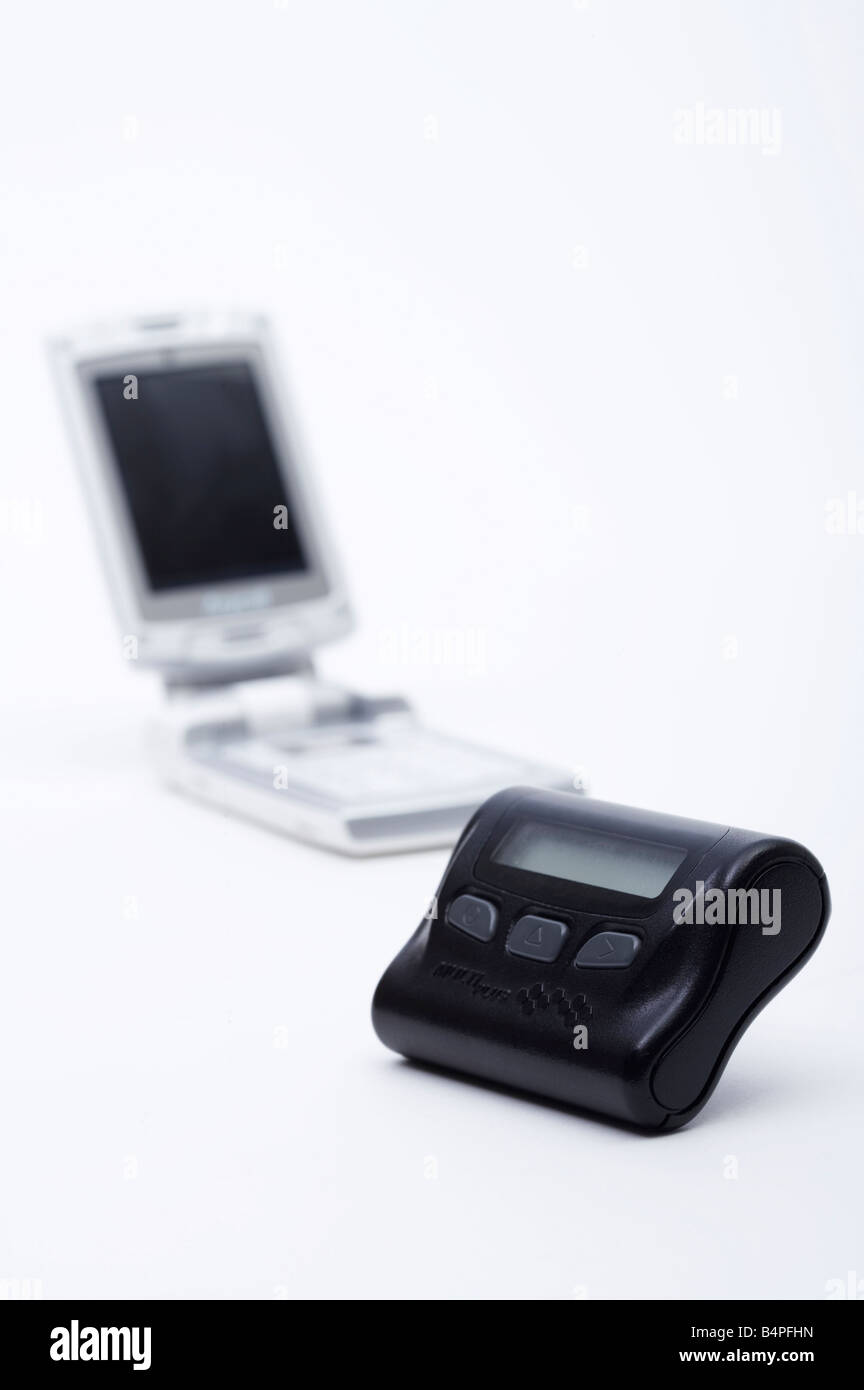 Mobile phone and pager against white background Stock Photo - Alamy