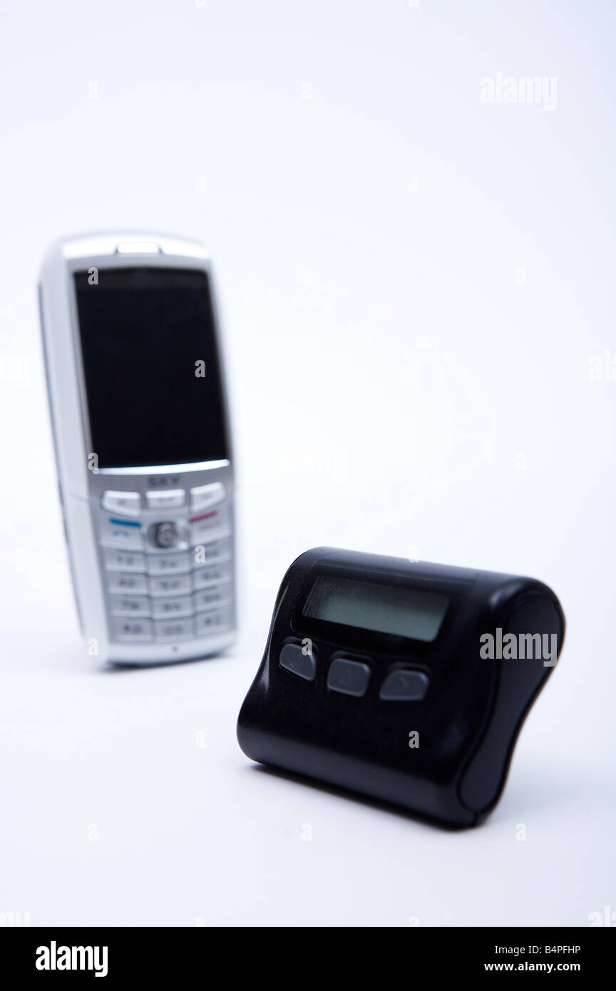 Mobile phone and pager against white background Stock Photo - Alamy