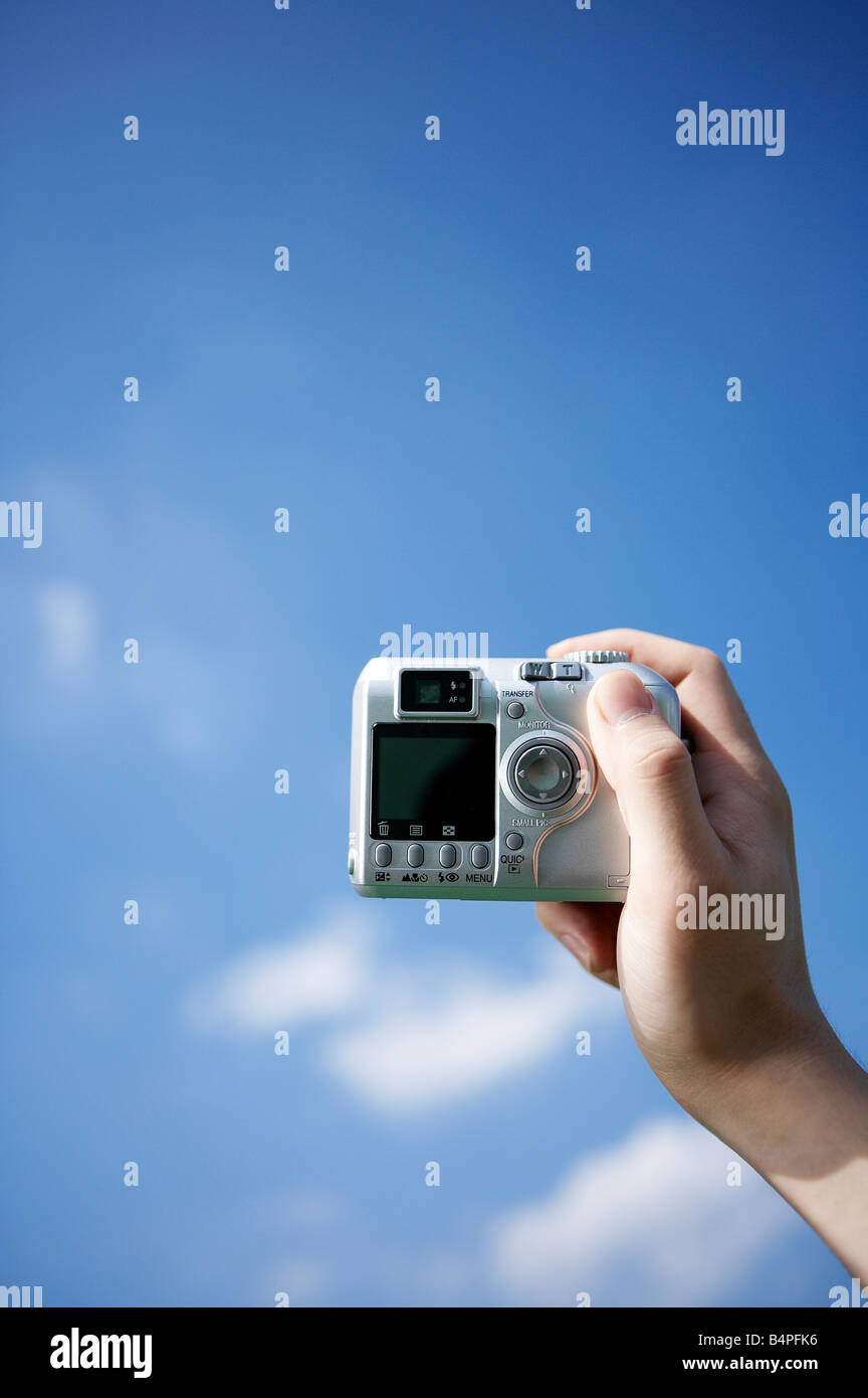 Human hand holding digital camera, close up Stock Photo - Alamy