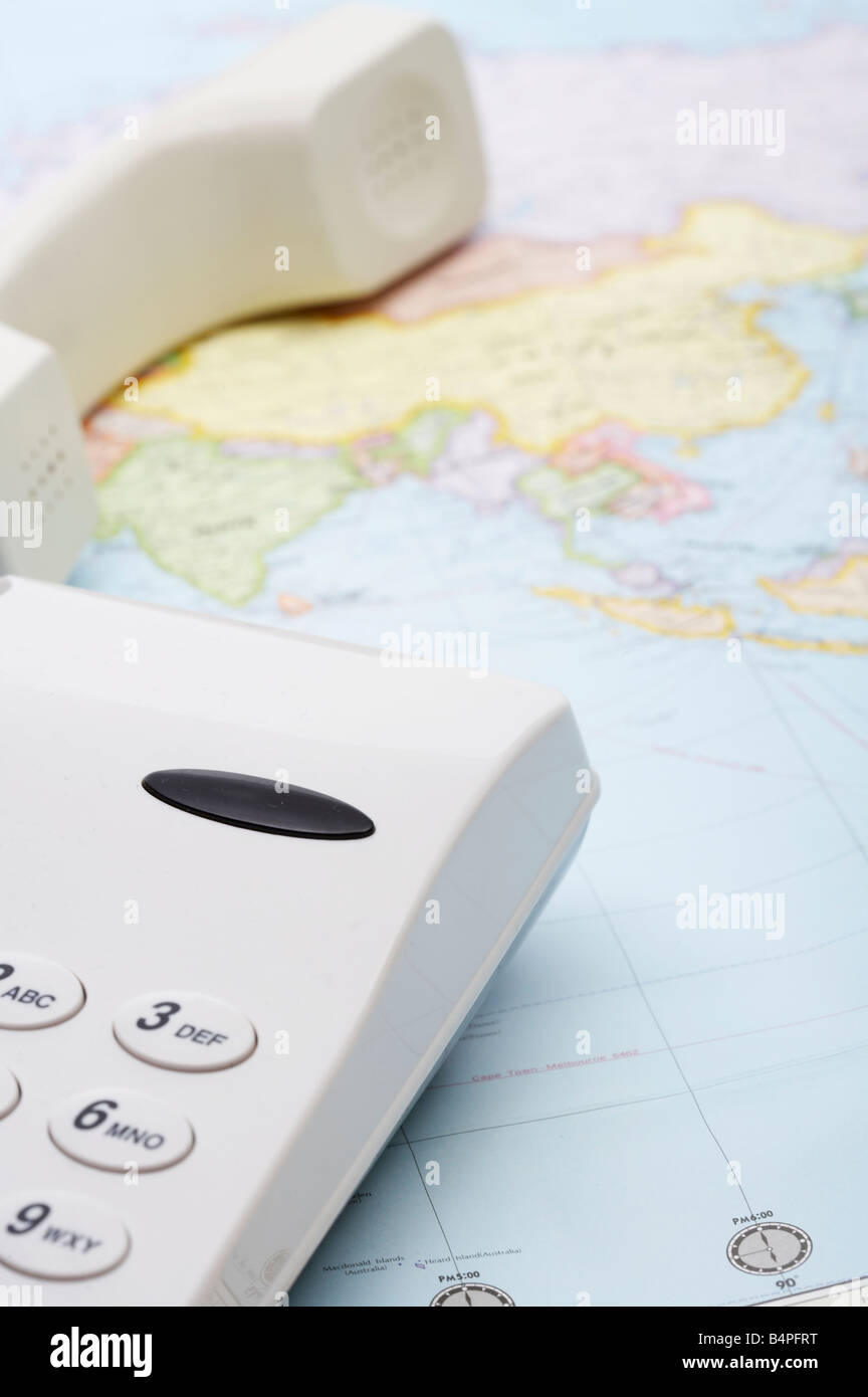 Land line phone on a world map Stock Photo - Alamy