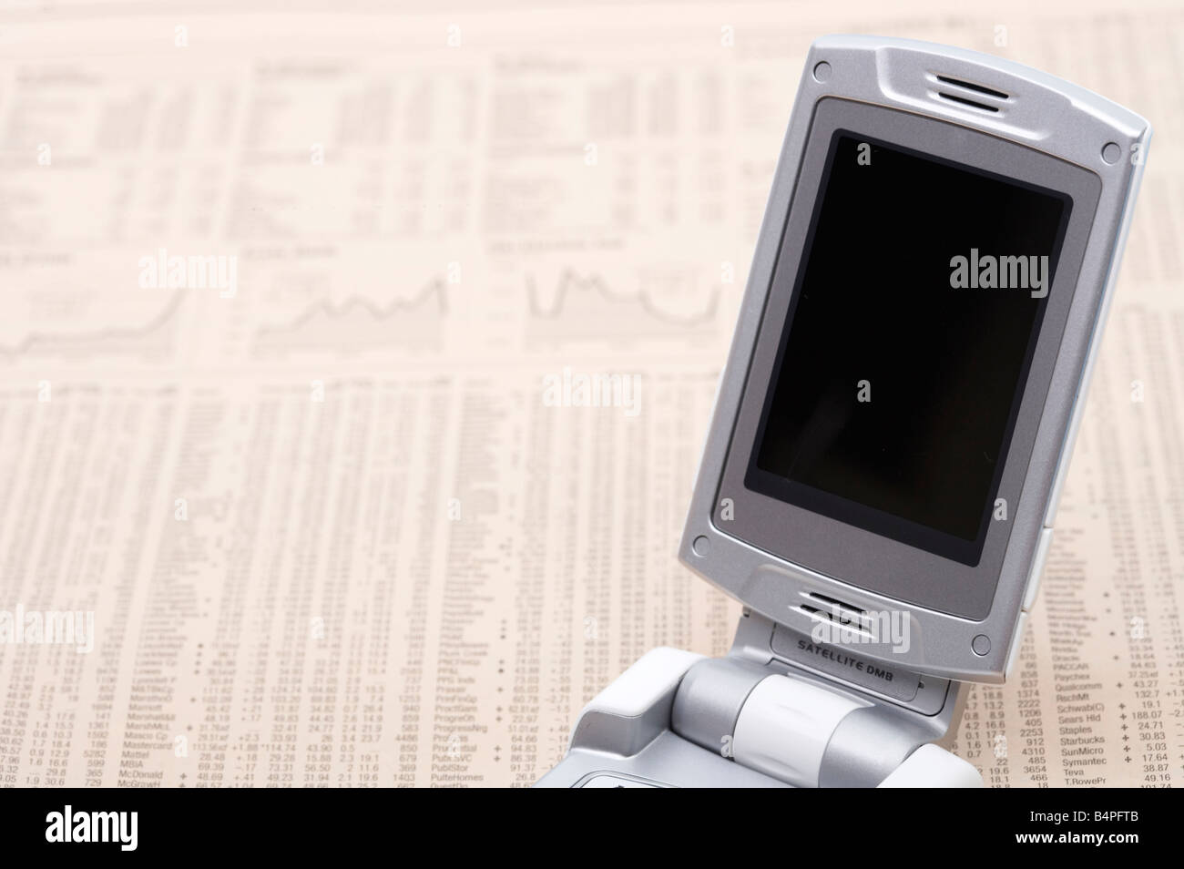 Mobile phone on a newspaper Stock Photo - Alamy