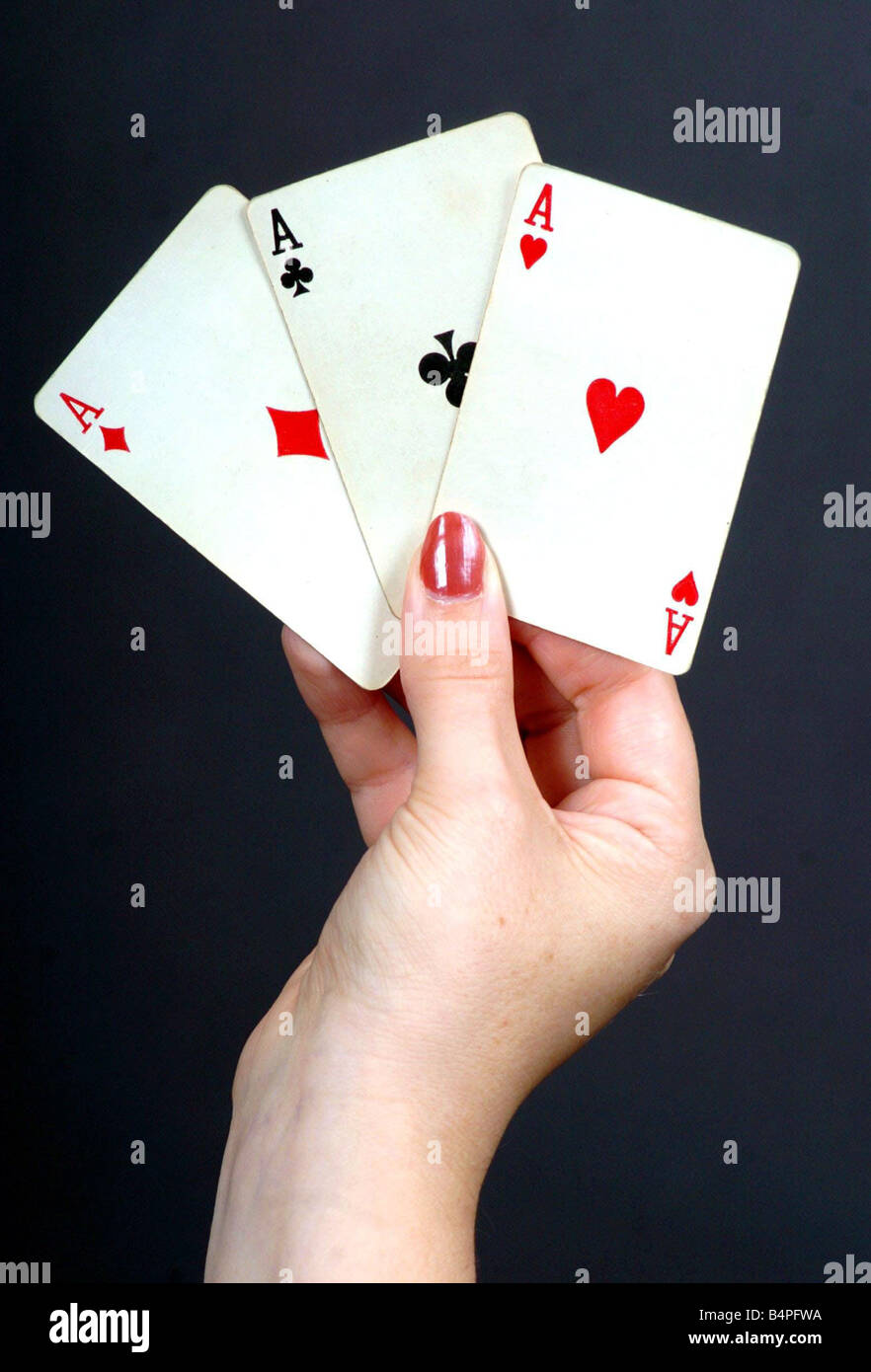 Woman s hand holding three playing cards April 2005 Stock Photo - Alamy