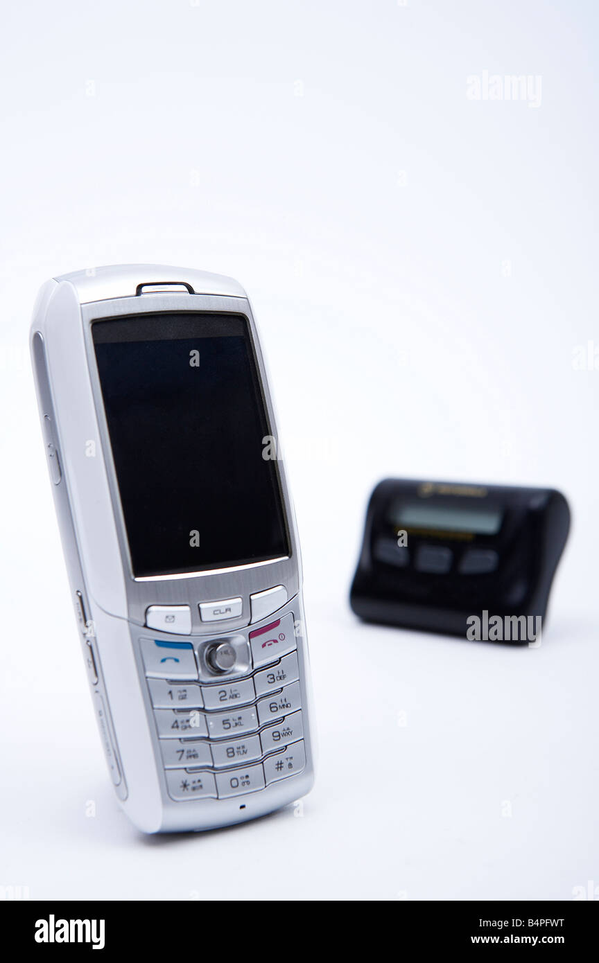 Mobile phone and pager against white background Stock Photo - Alamy