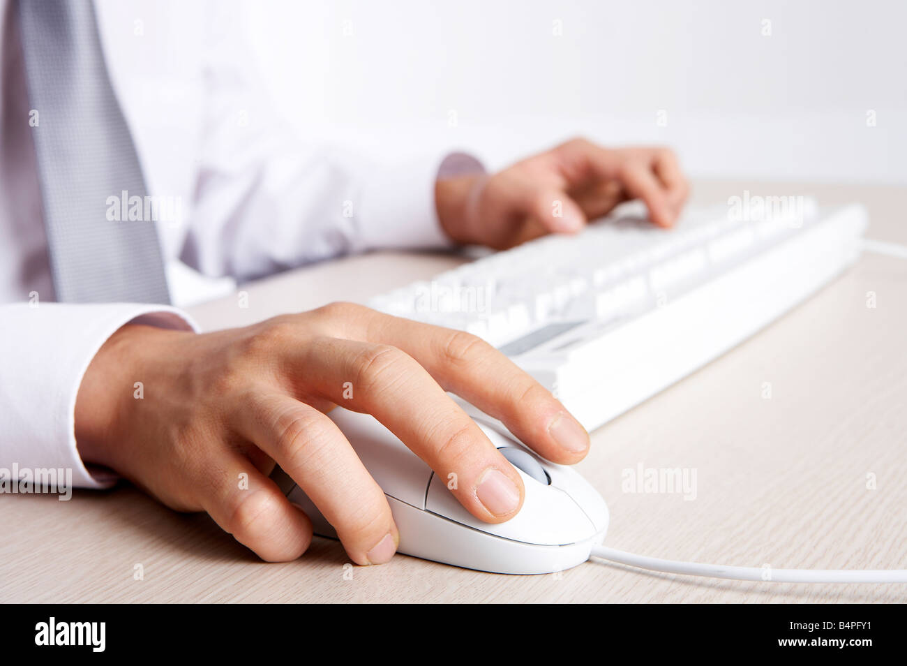 Man using computer mouse and keyboard Stock Photo - Alamy