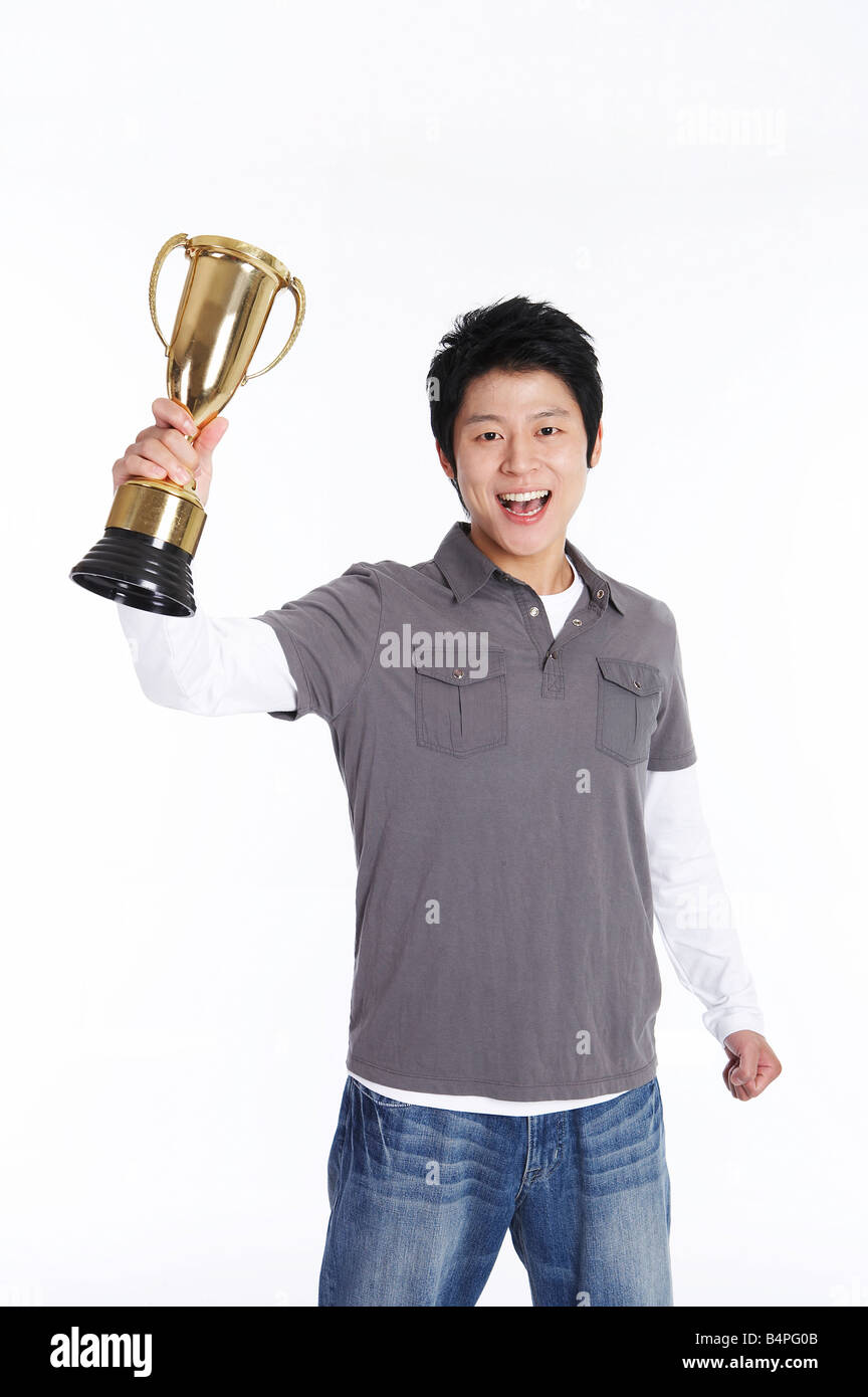 Asian man holding trophy hi-res stock photography and images - Alamy