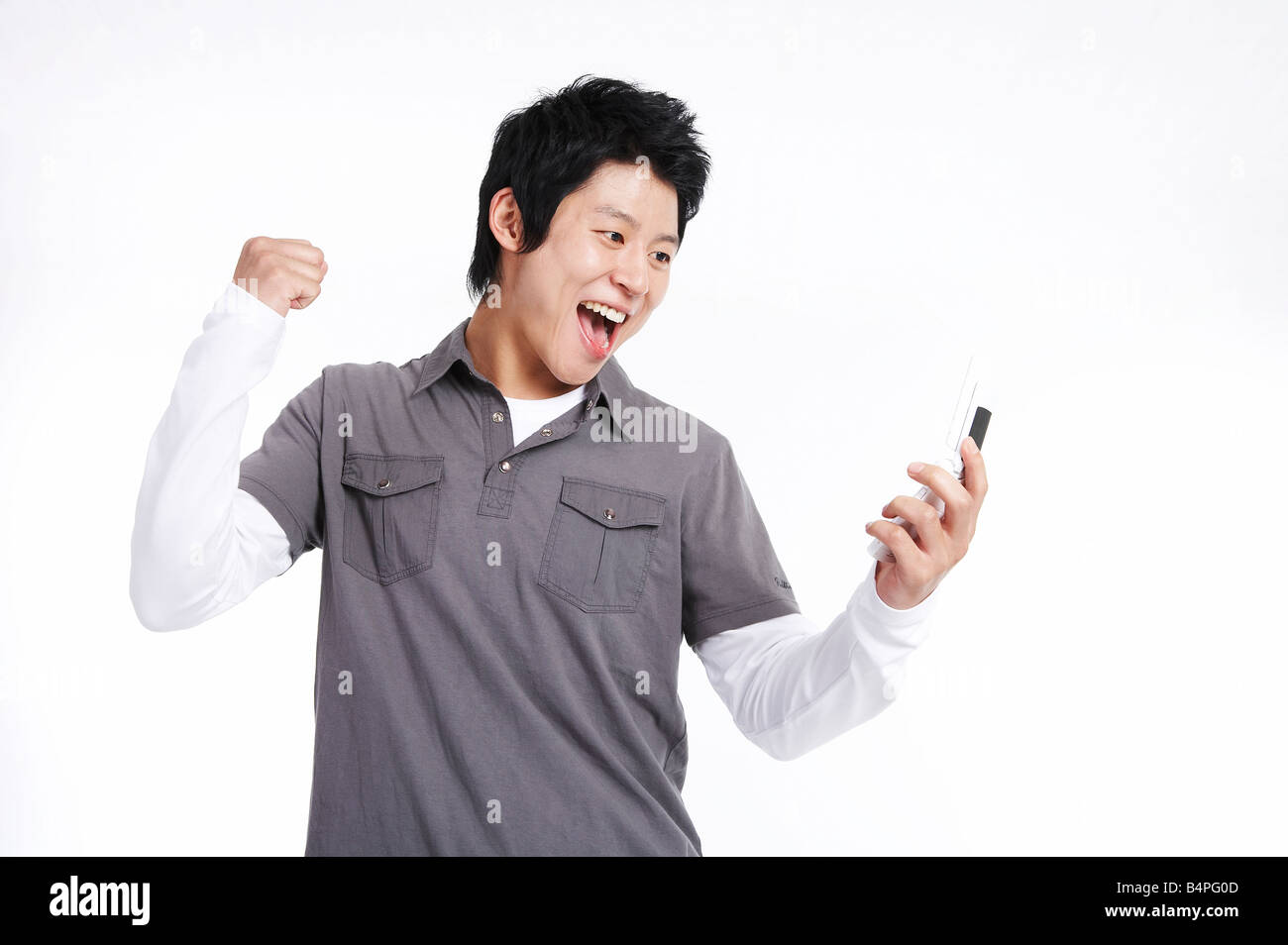 Young man holding mobile phone Stock Photo - Alamy