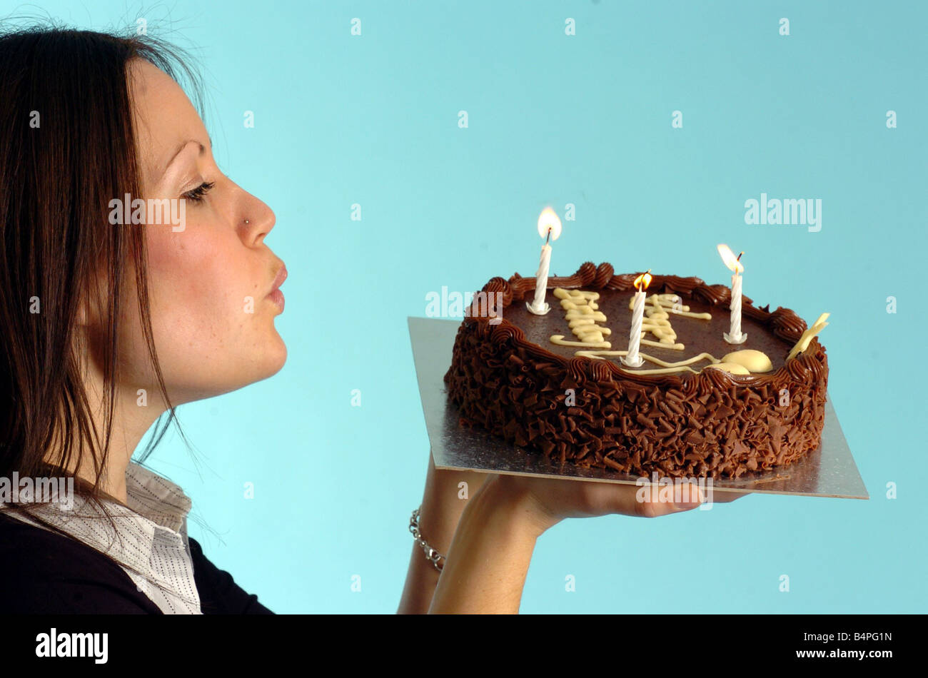 Woman blow out birthday cake chocolate hi-res stock photography and ...