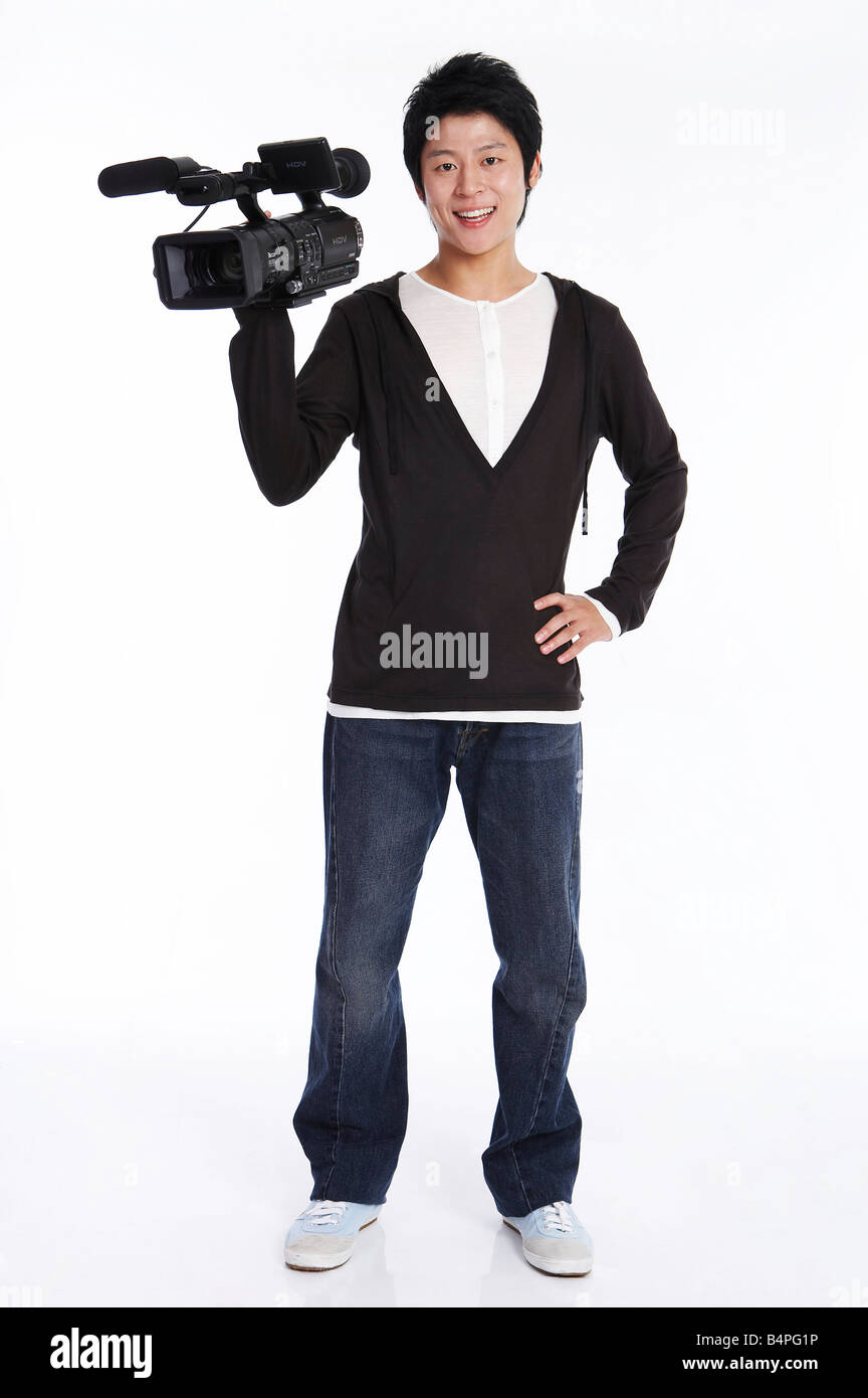 Young man holding video camera, portrait Stock Photo - Alamy