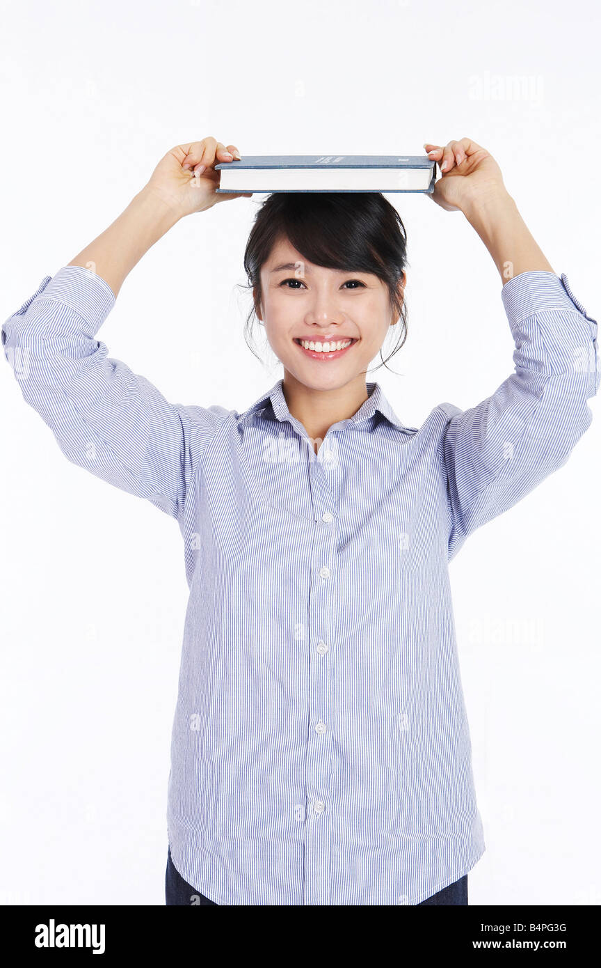 Woman balancing books head hi-res stock photography and images - Alamy