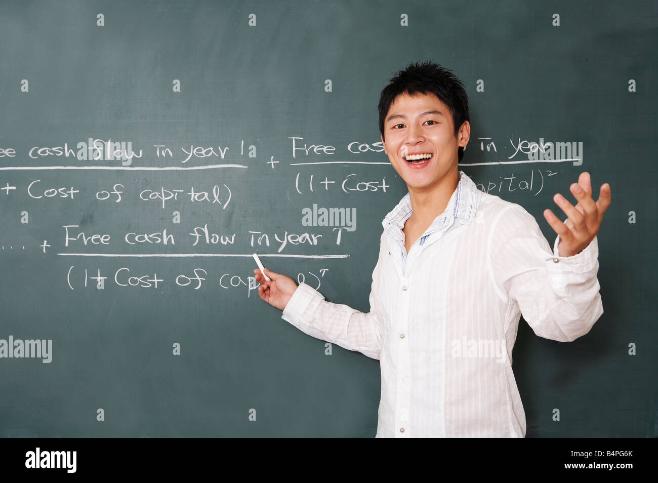 Young man writing on blackboard, portrait Stock Photo - Alamy