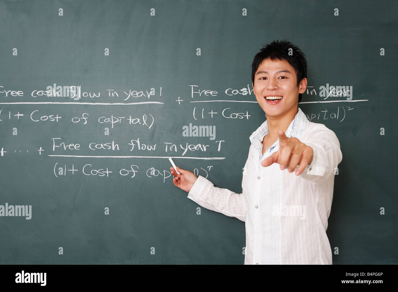 Young man writing on blackboard, portrait Stock Photo - Alamy