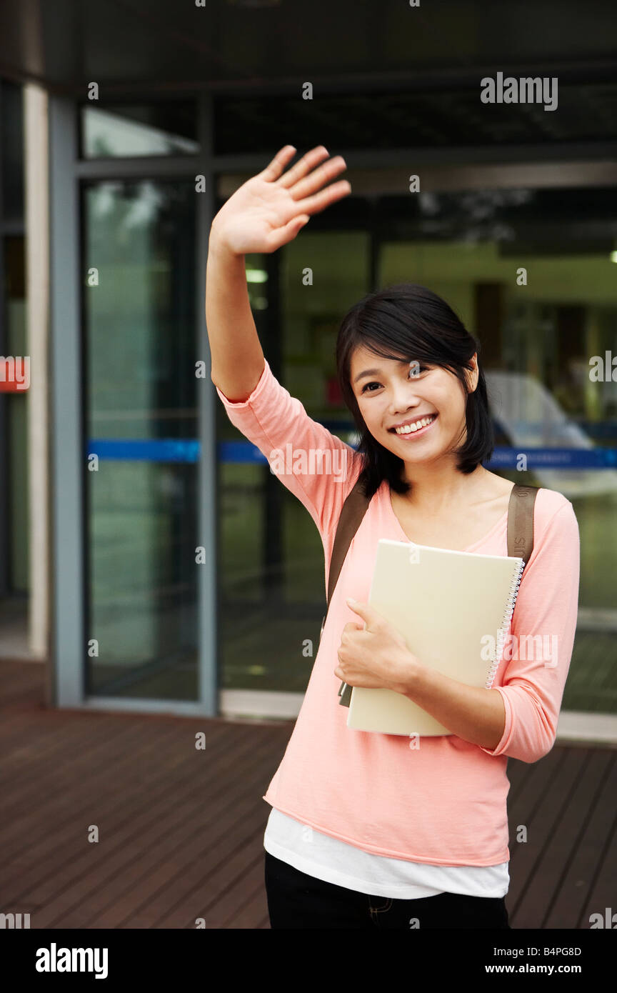 Young woman waving her hand Stock Photo - Alamy