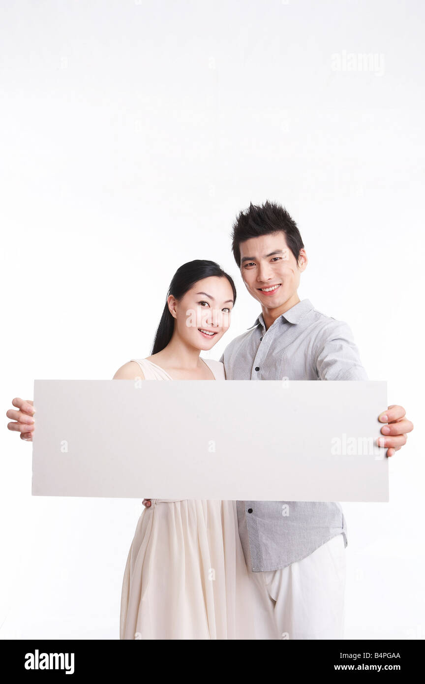 Young couple holding blank placard Stock Photo - Alamy Young couple holding blank placard Stock Photo - Alamy