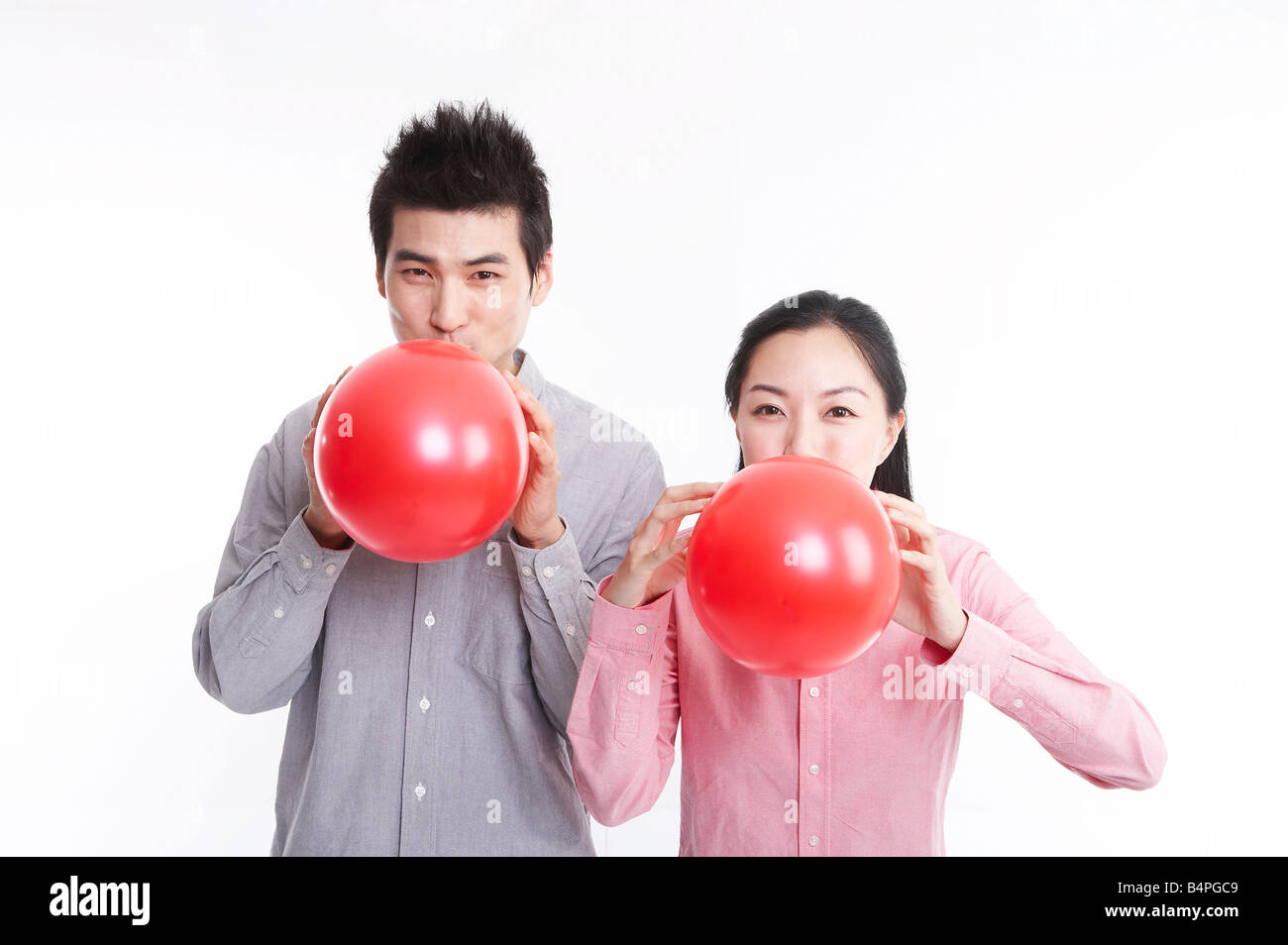 Women blowing up balloon hi-res stock photography and images - Alamy